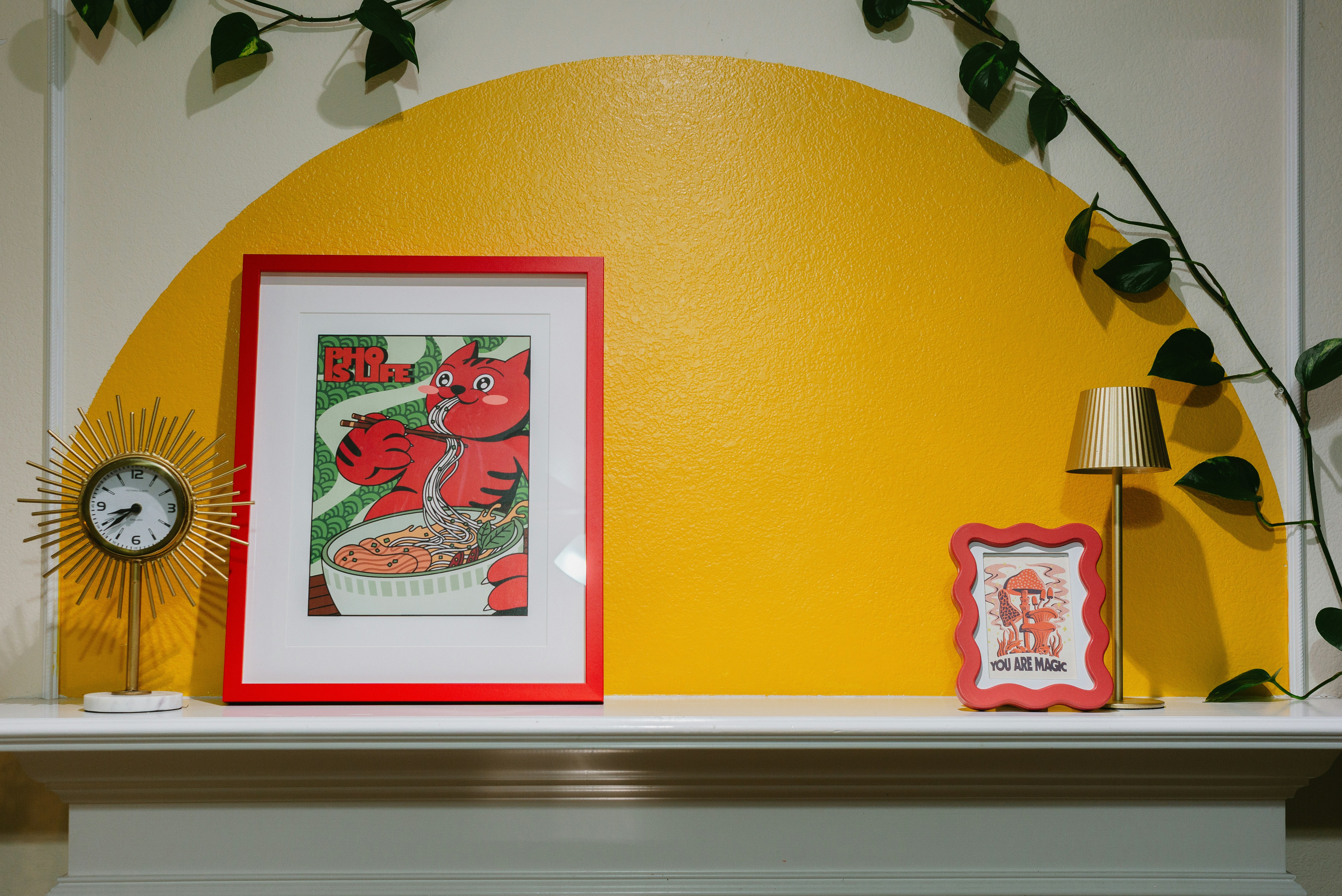 Sunlit Mantel: A Bright Yellow Backdrop Framing Framed Cat Art