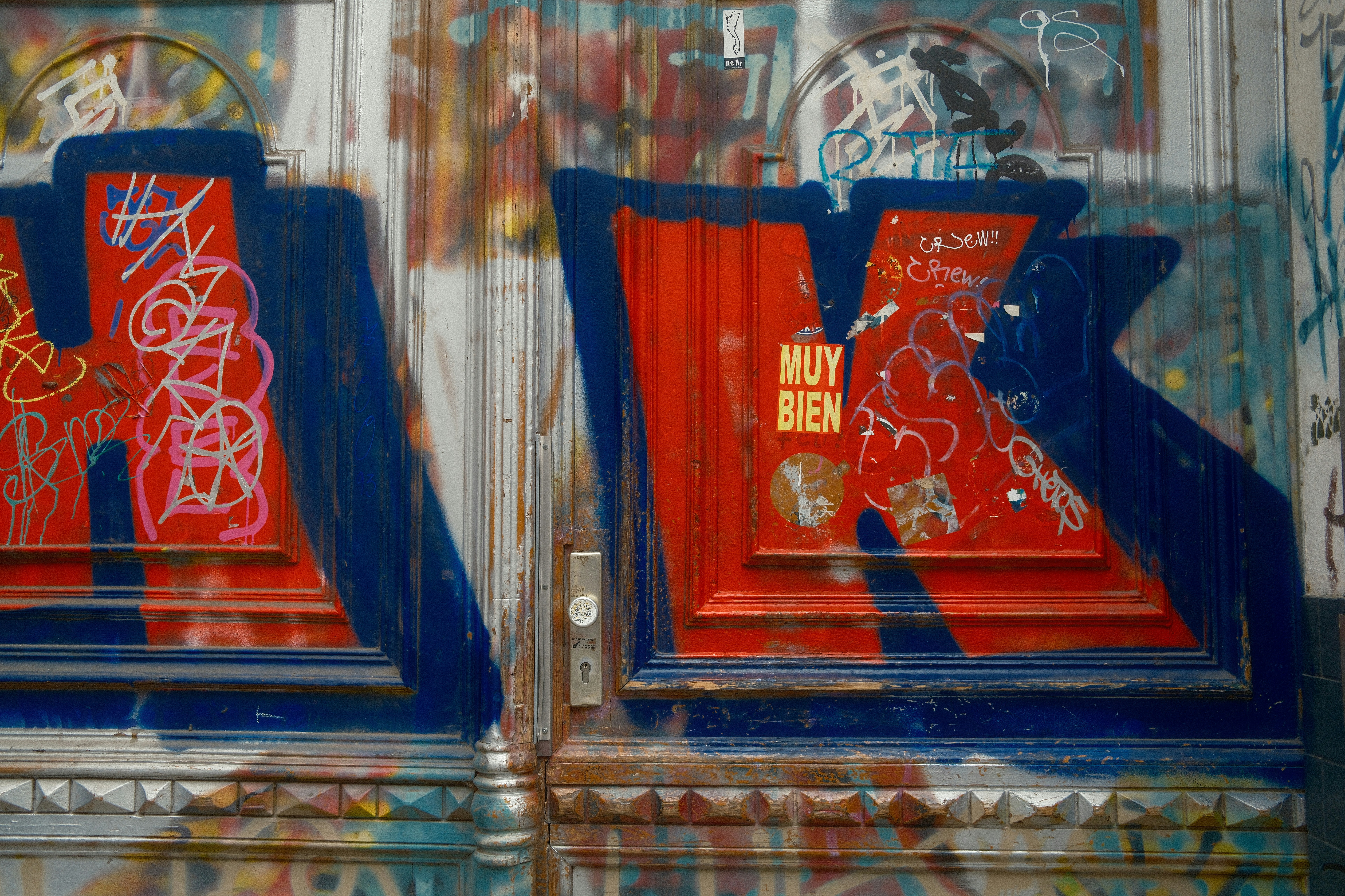 Graffiti Doors: A Colorful Jam of Blues and Reds