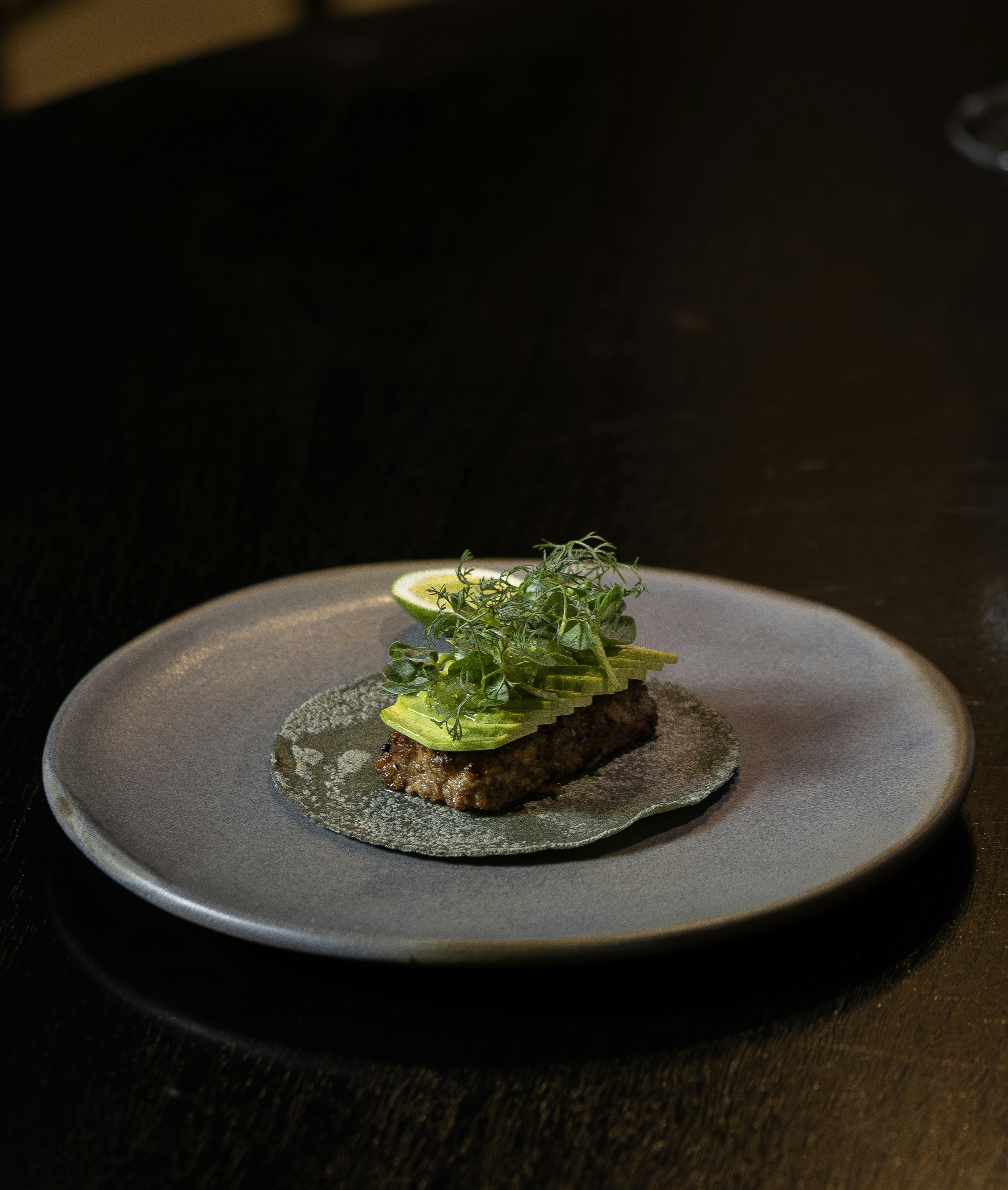 A Tiny Herb-Topped Steak on a Moonlit Plate