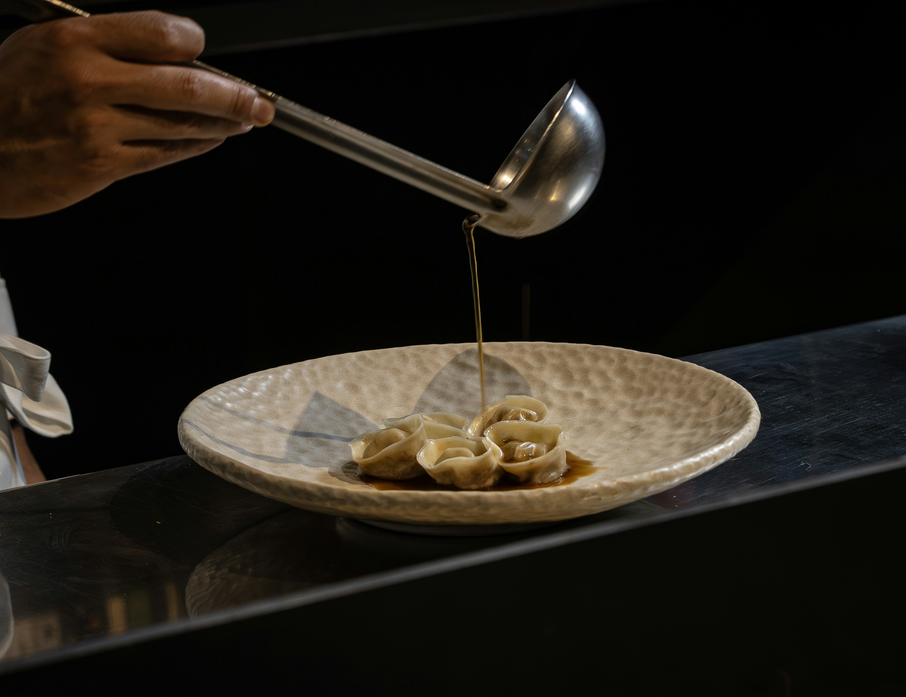 Ladle of Satin: Delicate Pour on a Plate