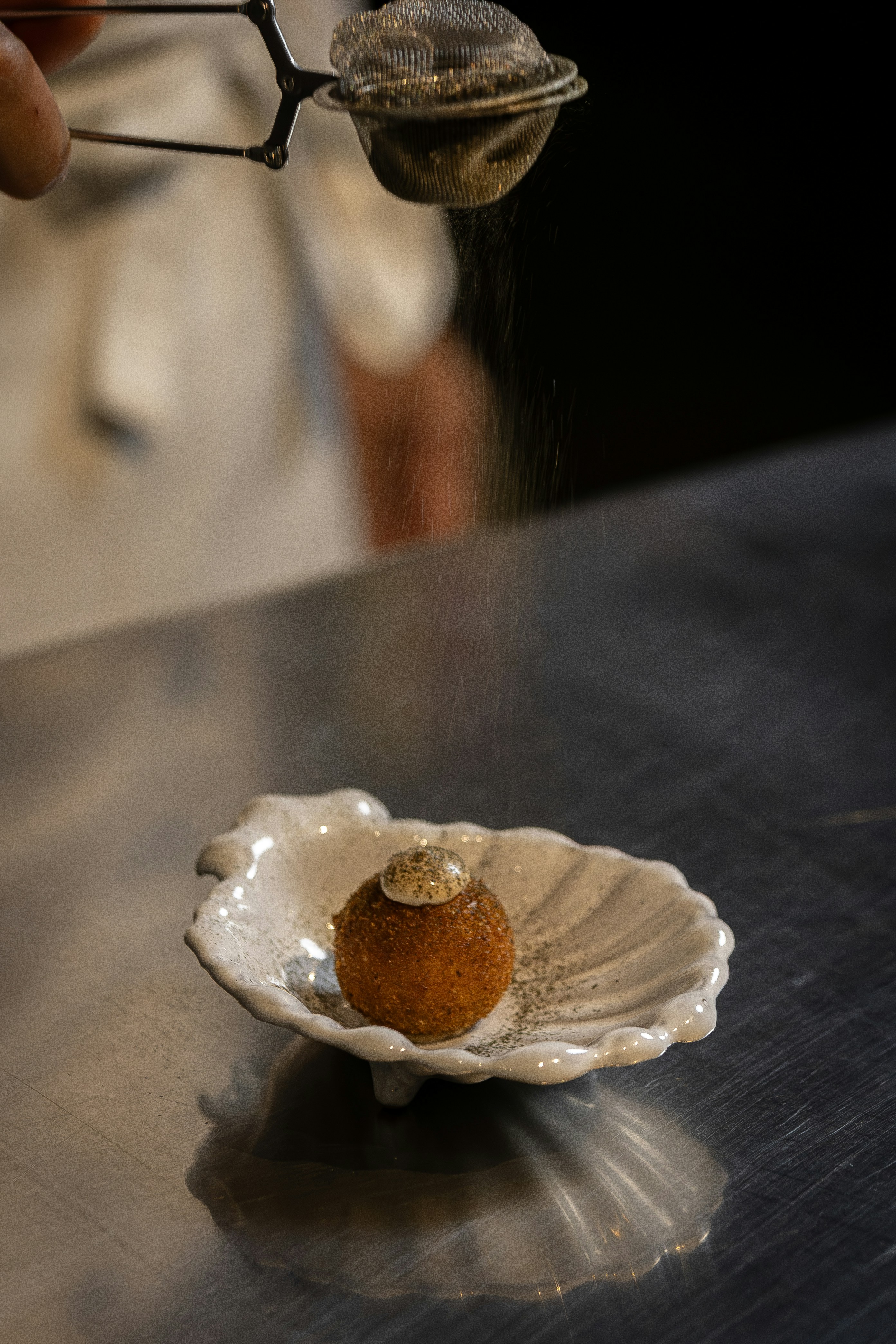 Powdered Salt and a Tiny Sphere: A Delicate Culinary Moment