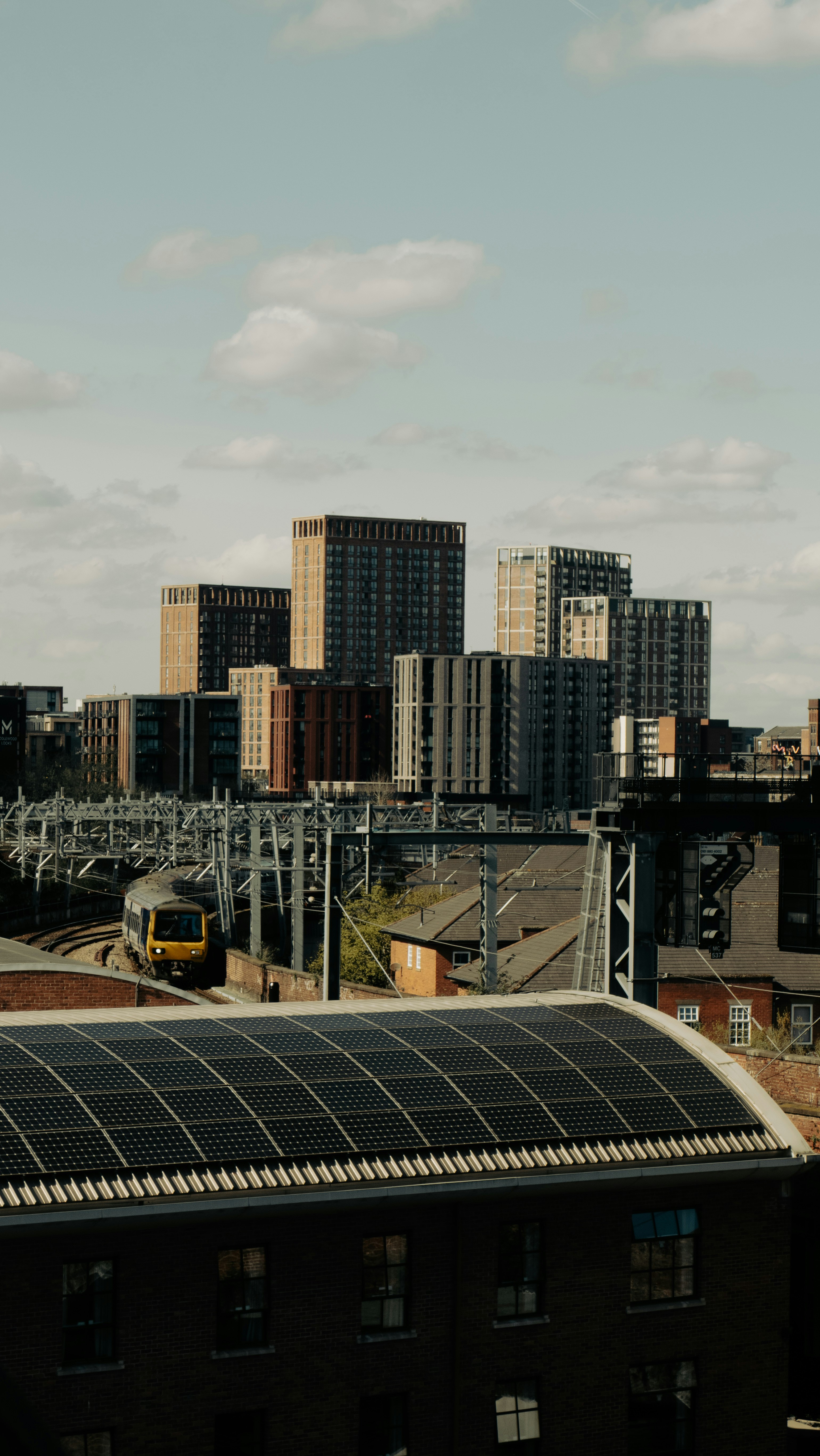 City Rise: Train, Rooftops, and Distant High-Rines