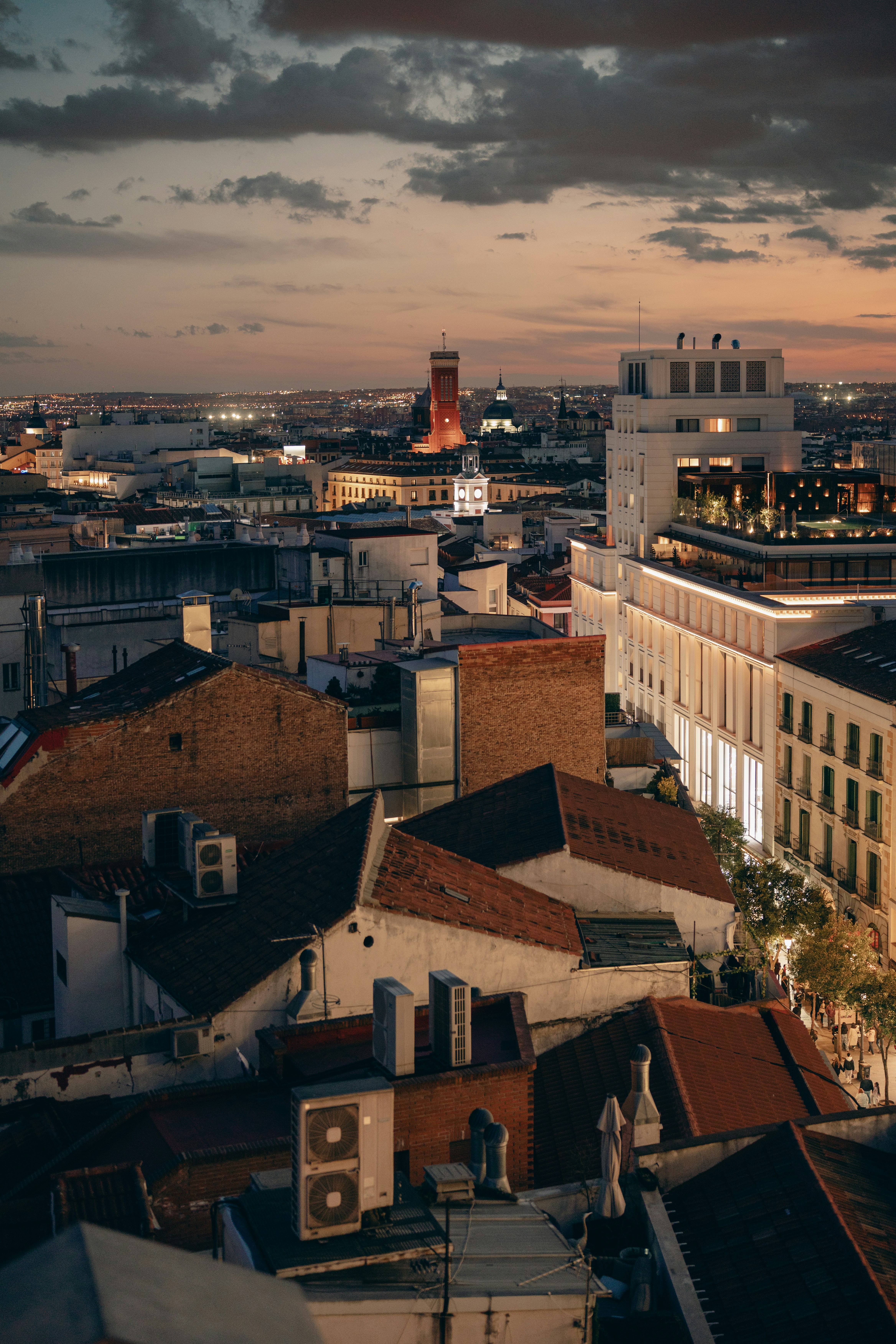 Dusk Over Rooftops: A Cityscape with Warm Gridlines