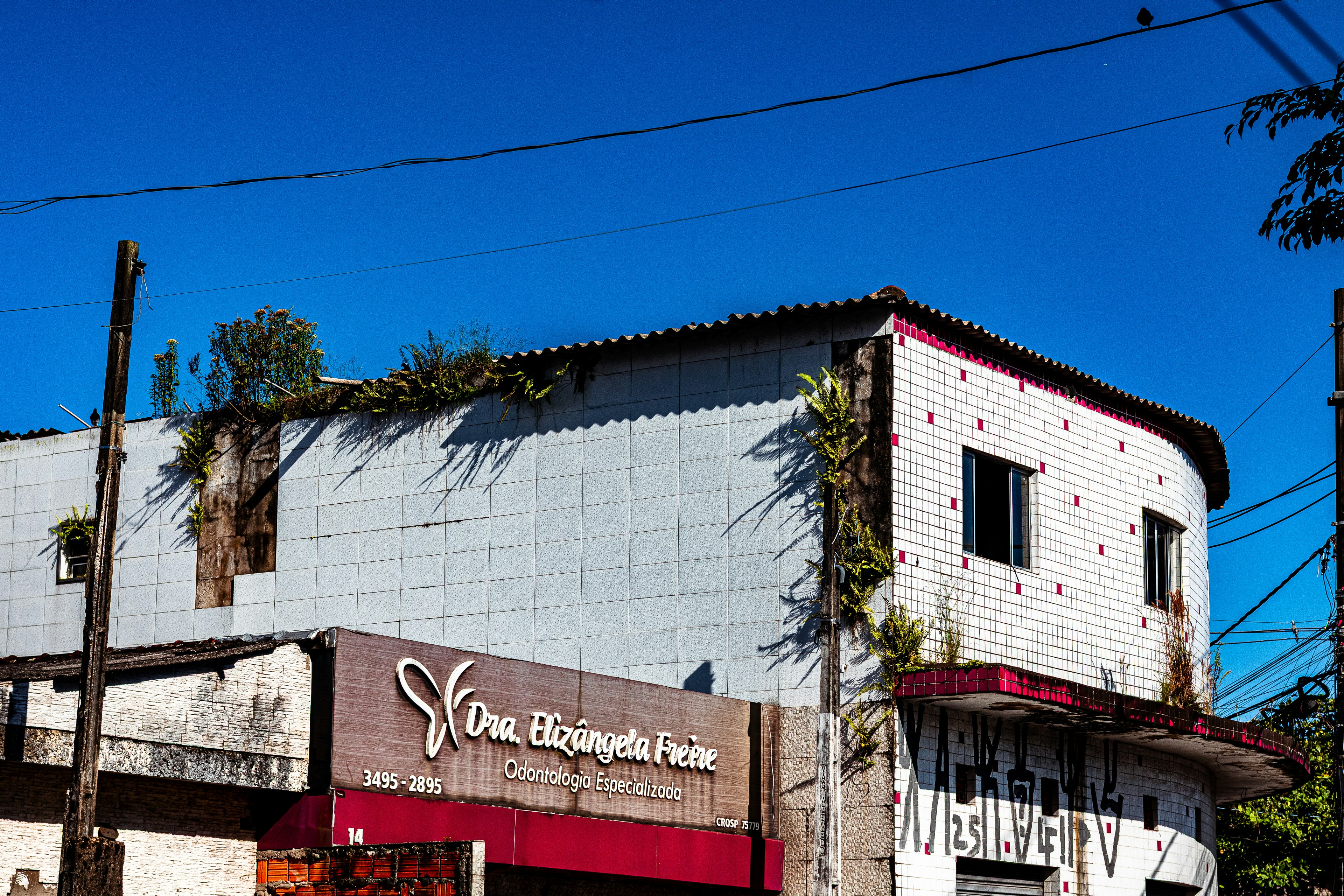 Sunlit Corner Storefront Beneath a Bright Blue Sky