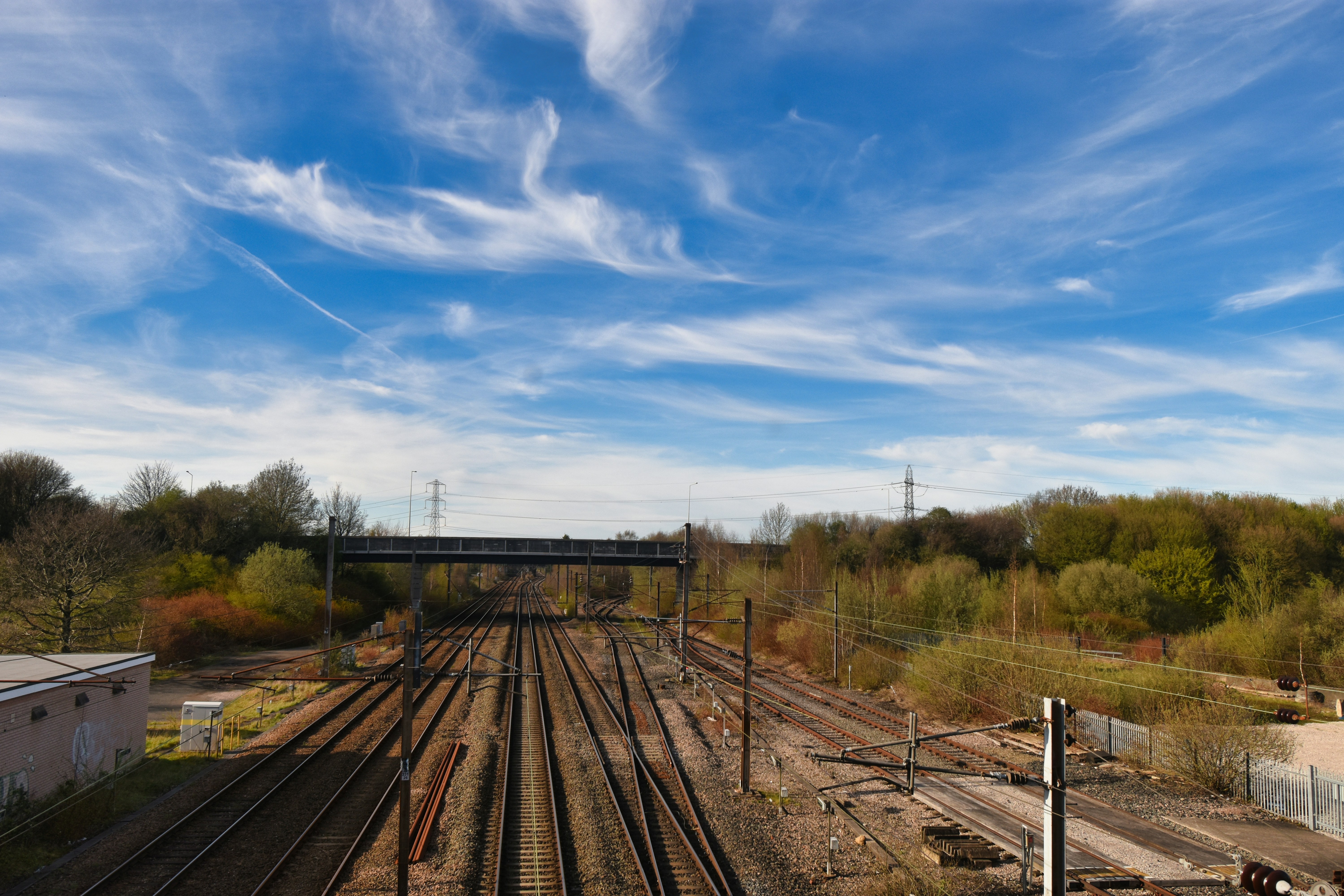 Horizon Rails: Converging Tracks Beneath a Bright Sky