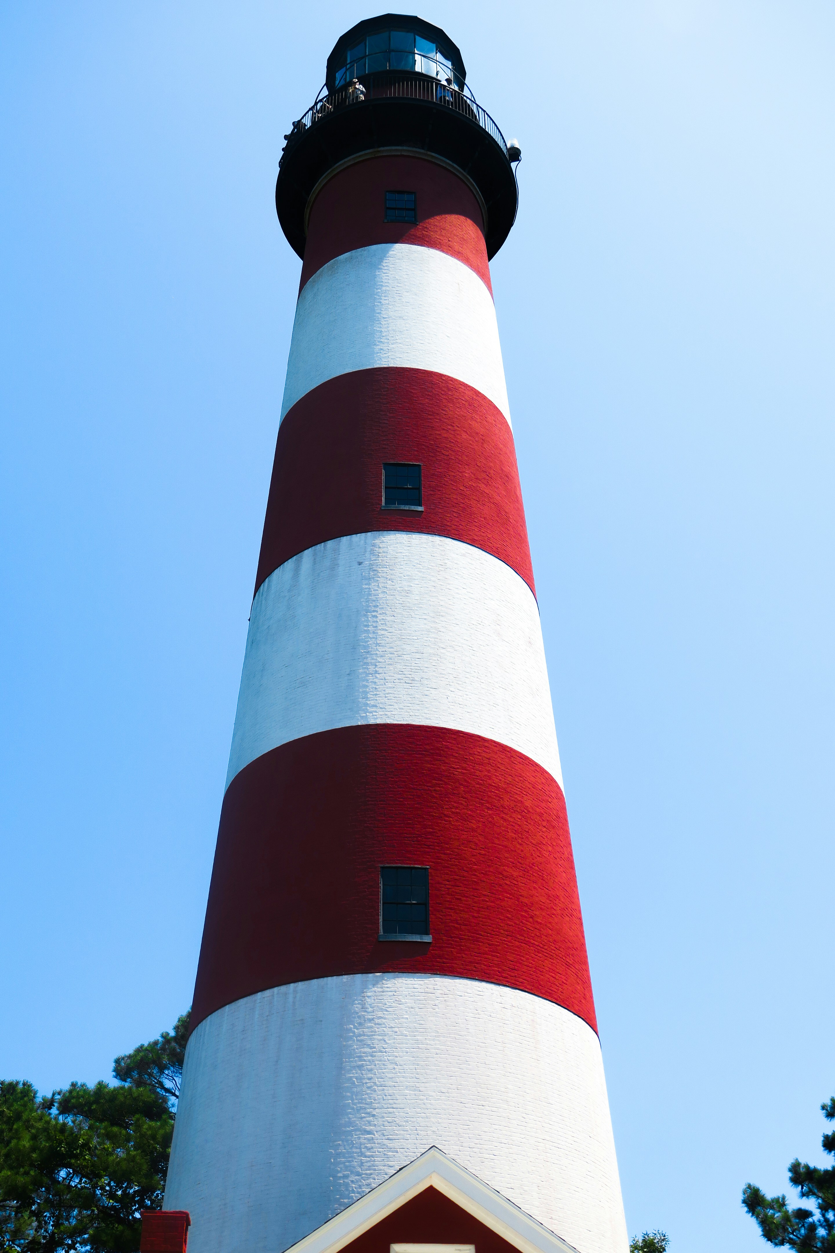 Stripe of the Beacon: A Crimson-White Lighthouse Reaches for the Sky