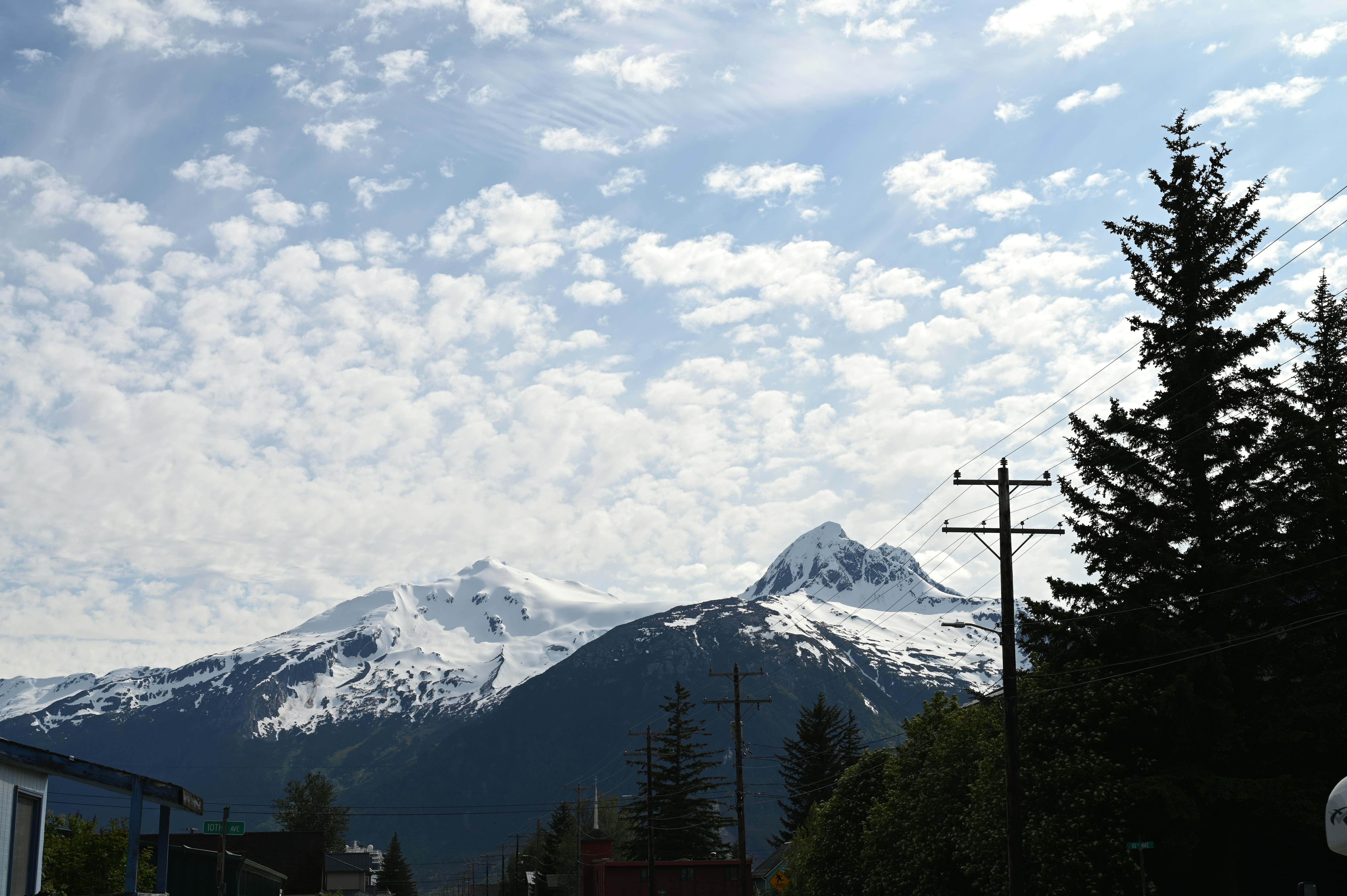 Snow-kissed Peaks Framed by a Quiet Valley Road