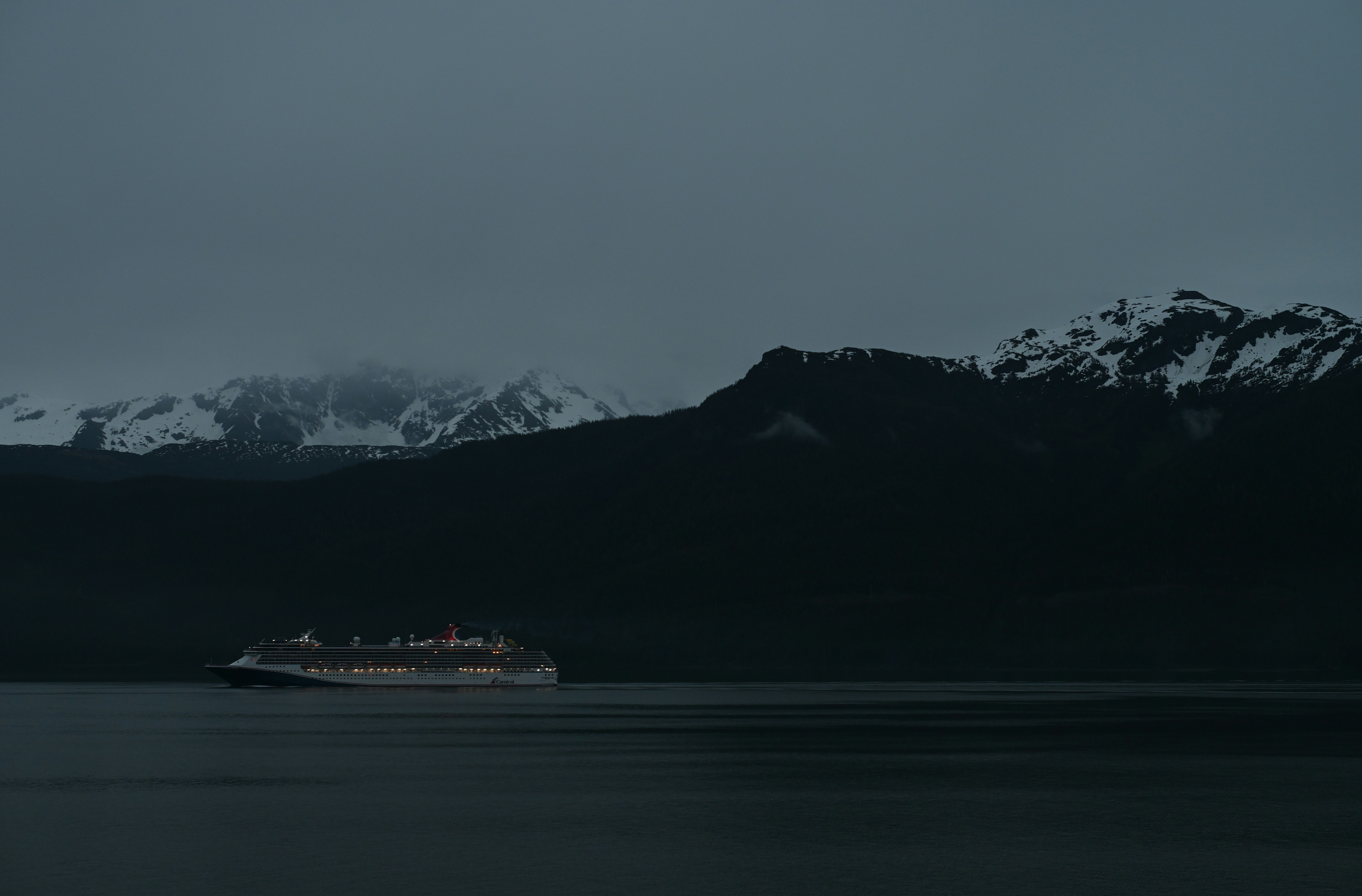 Midnight Cruise: A Quiet Vessel Against Glaciered Backdrop