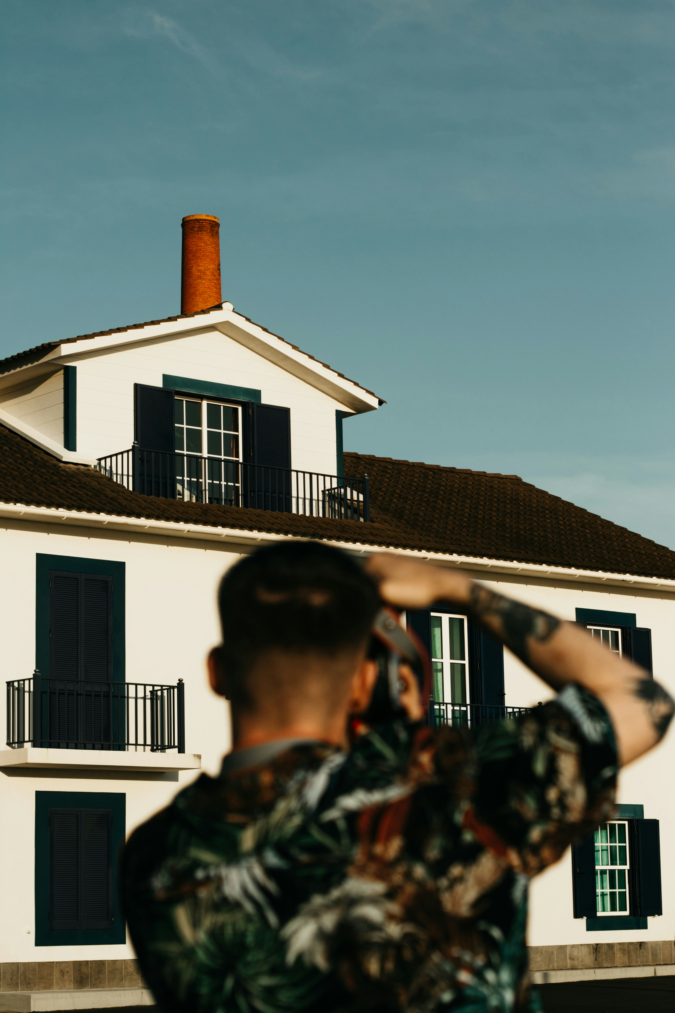 Portrait of a Photographer: Blurred Figure in Front of a Cottage