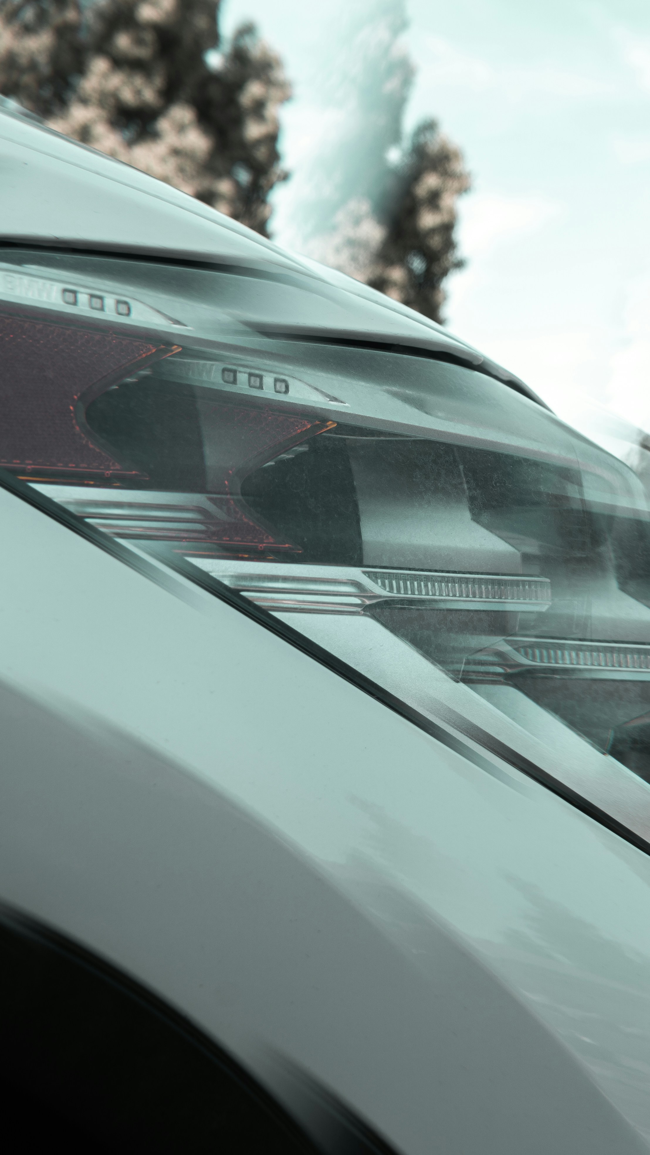 Close-Up of a Modern Vehicle Headlight and Hood Contour