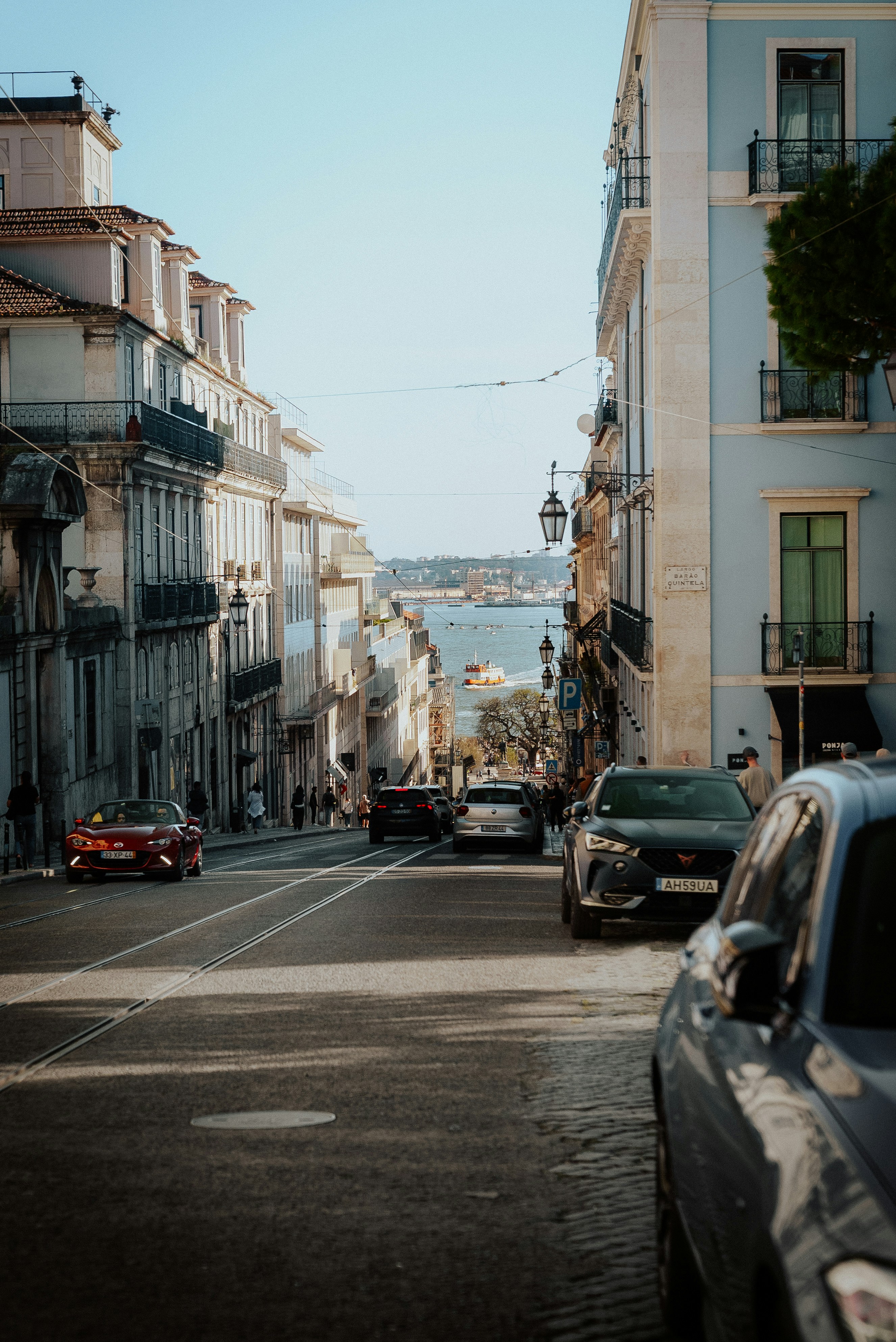 Sunlit Street Toward the Harbor: A Quiet Urban Ascent