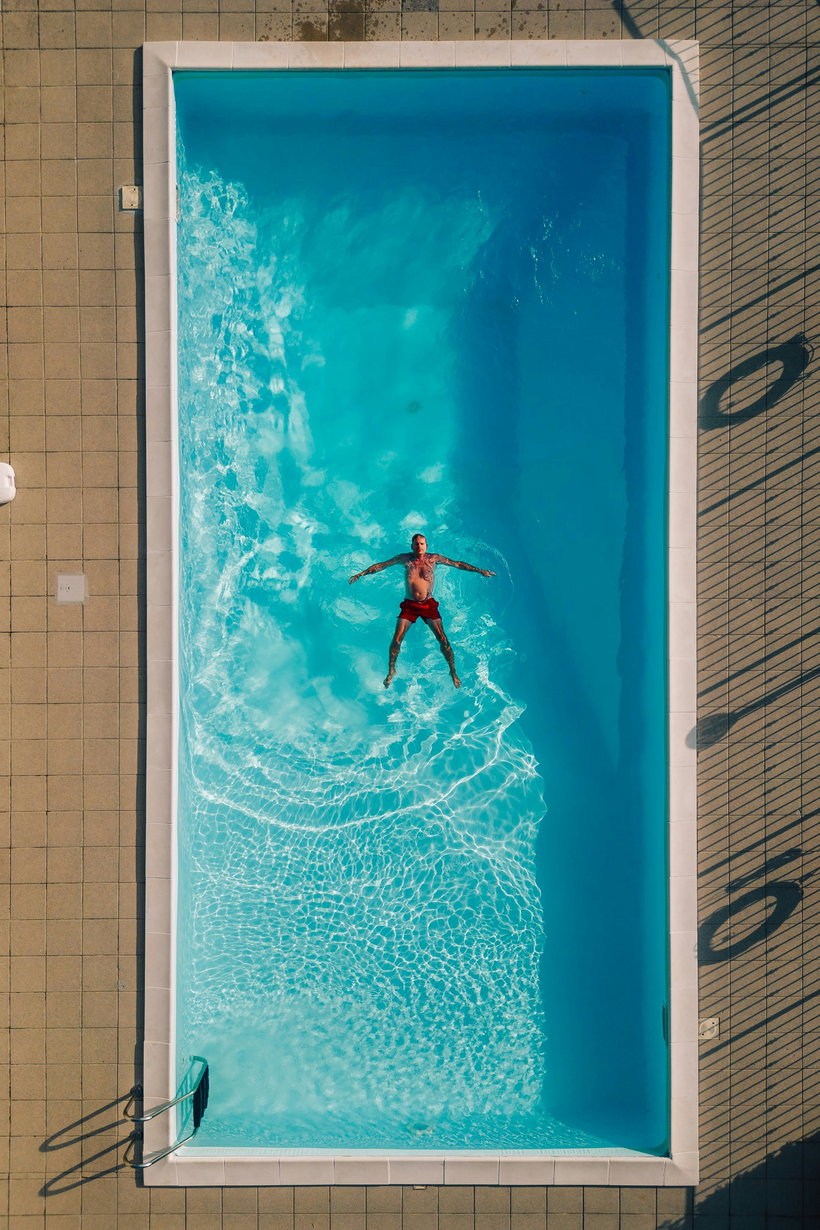 Aerial Dive: Surfer of the Aquamarine Pool