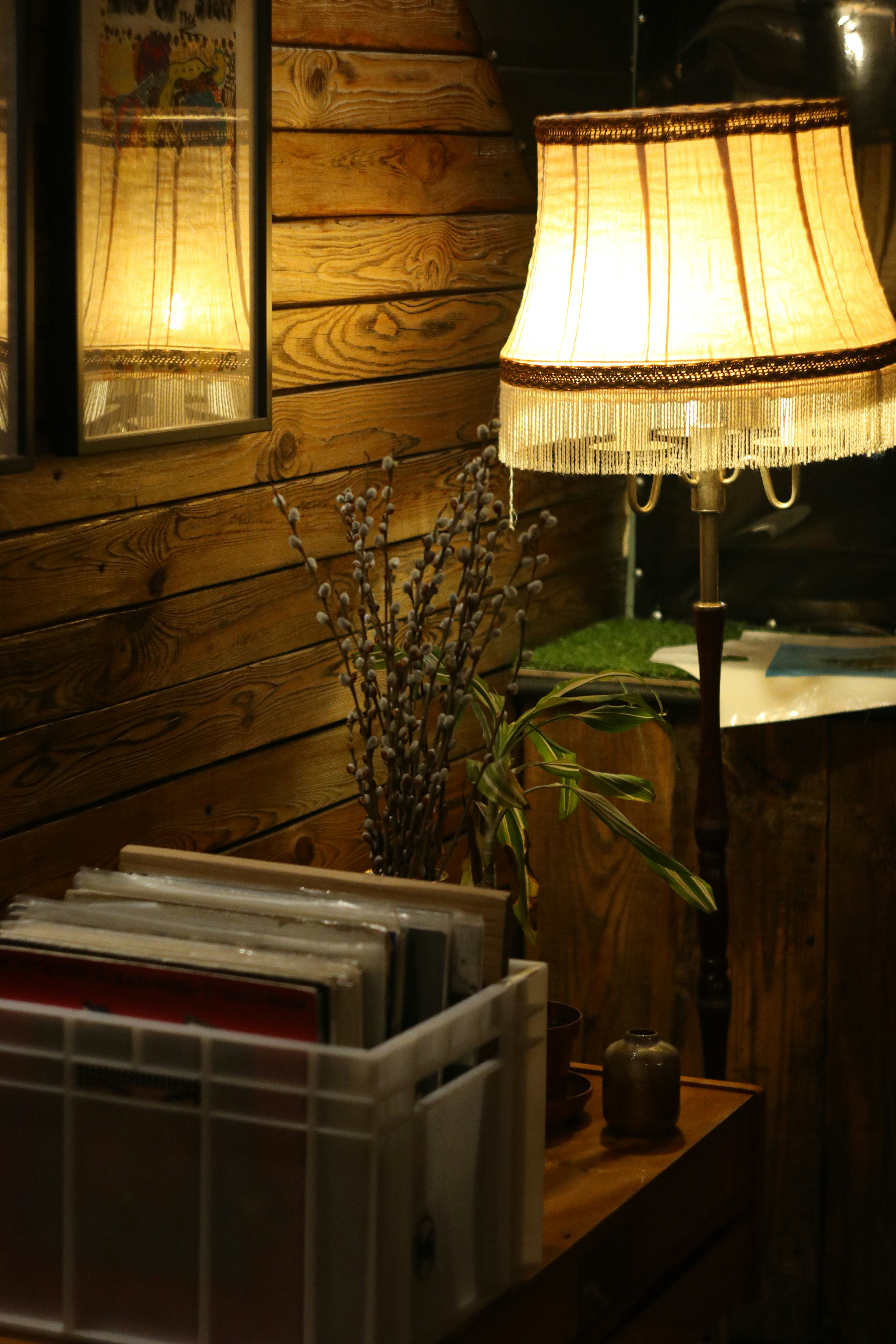 Warm Corner: The Glow of a Vintage Lamp in a Wood-Walled Nook