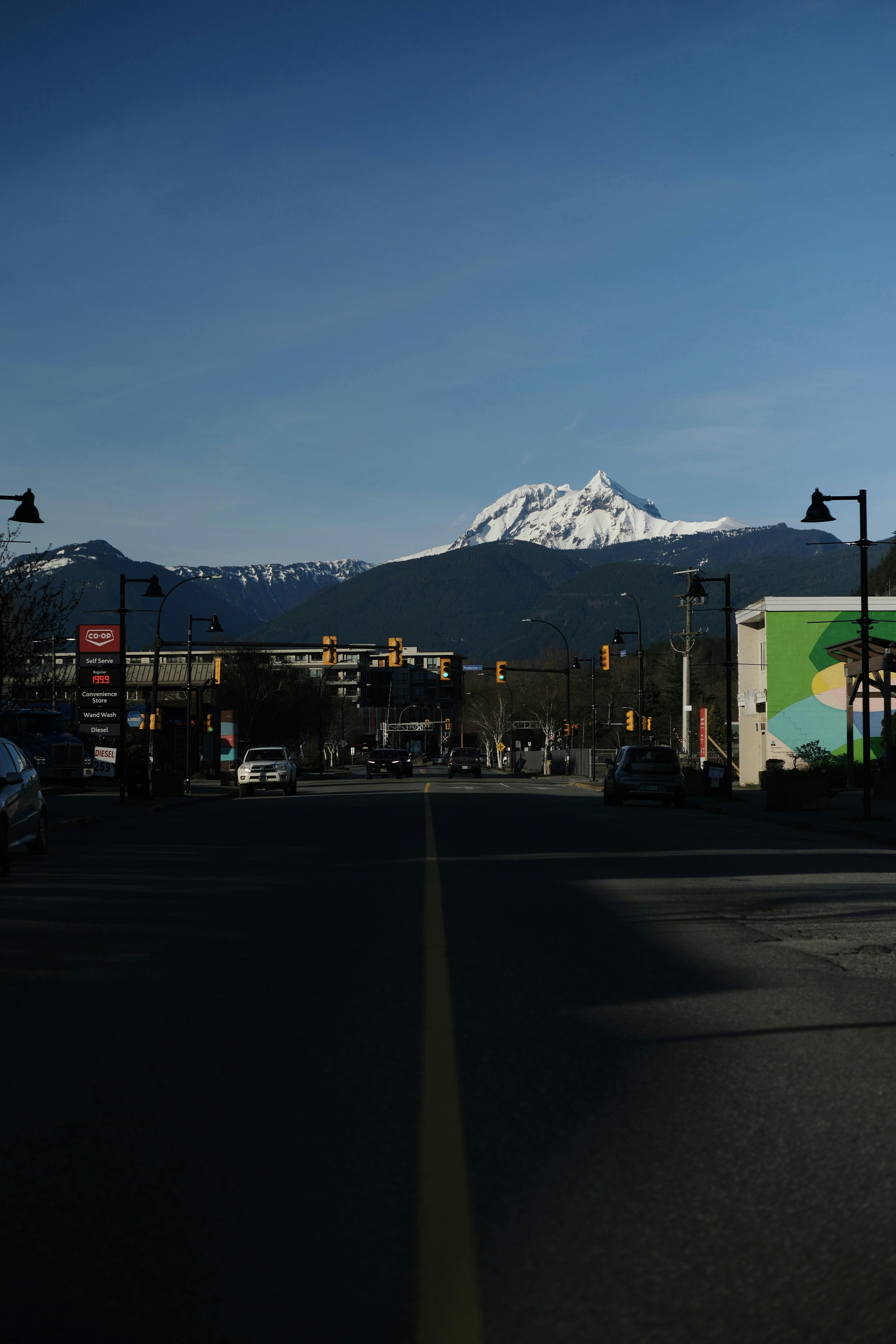 Snow-Capped Peak Over a Quiet City Street