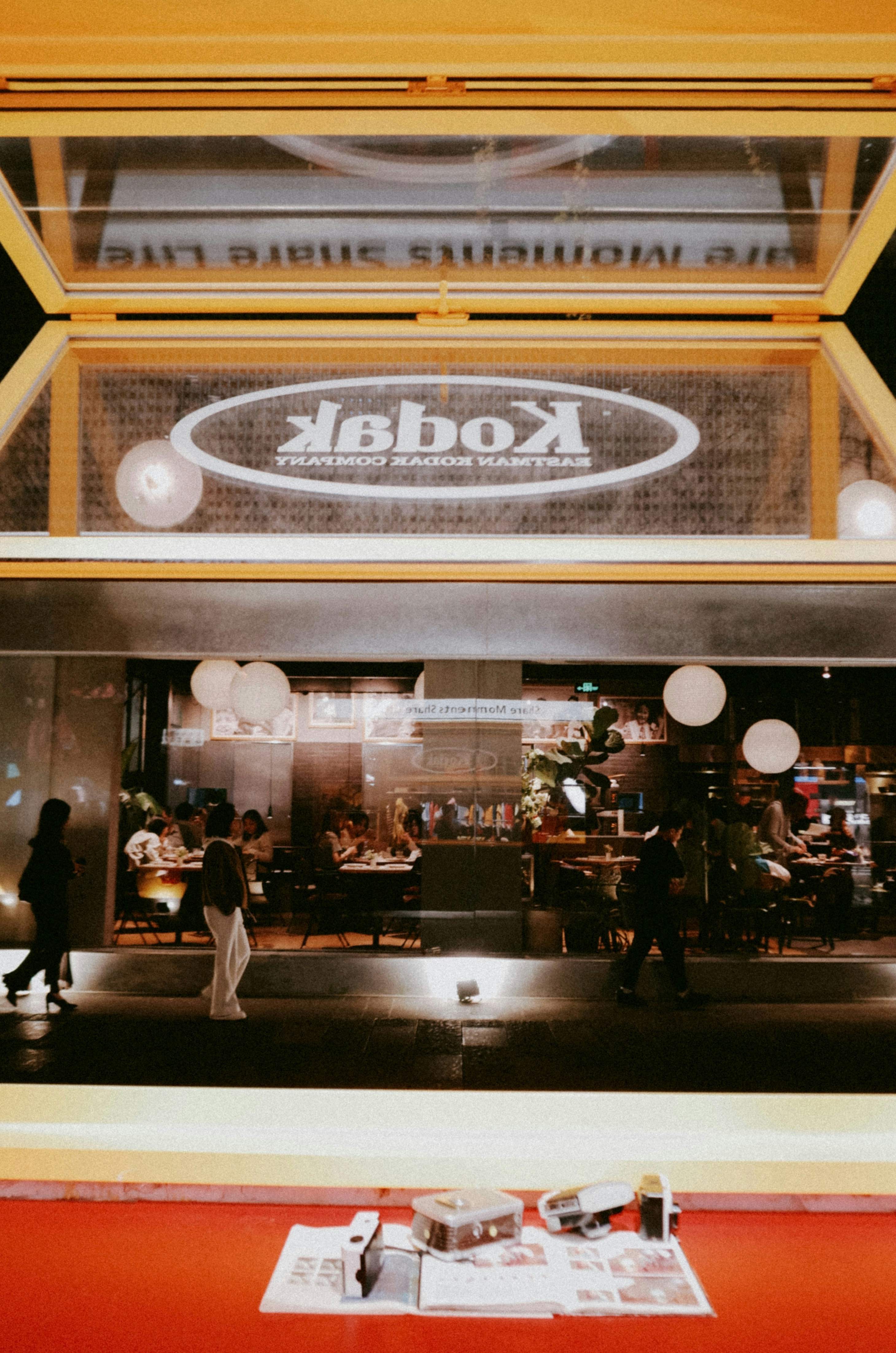 Coffeehouse Reflections: Neon Sign, People, and Steel Glass