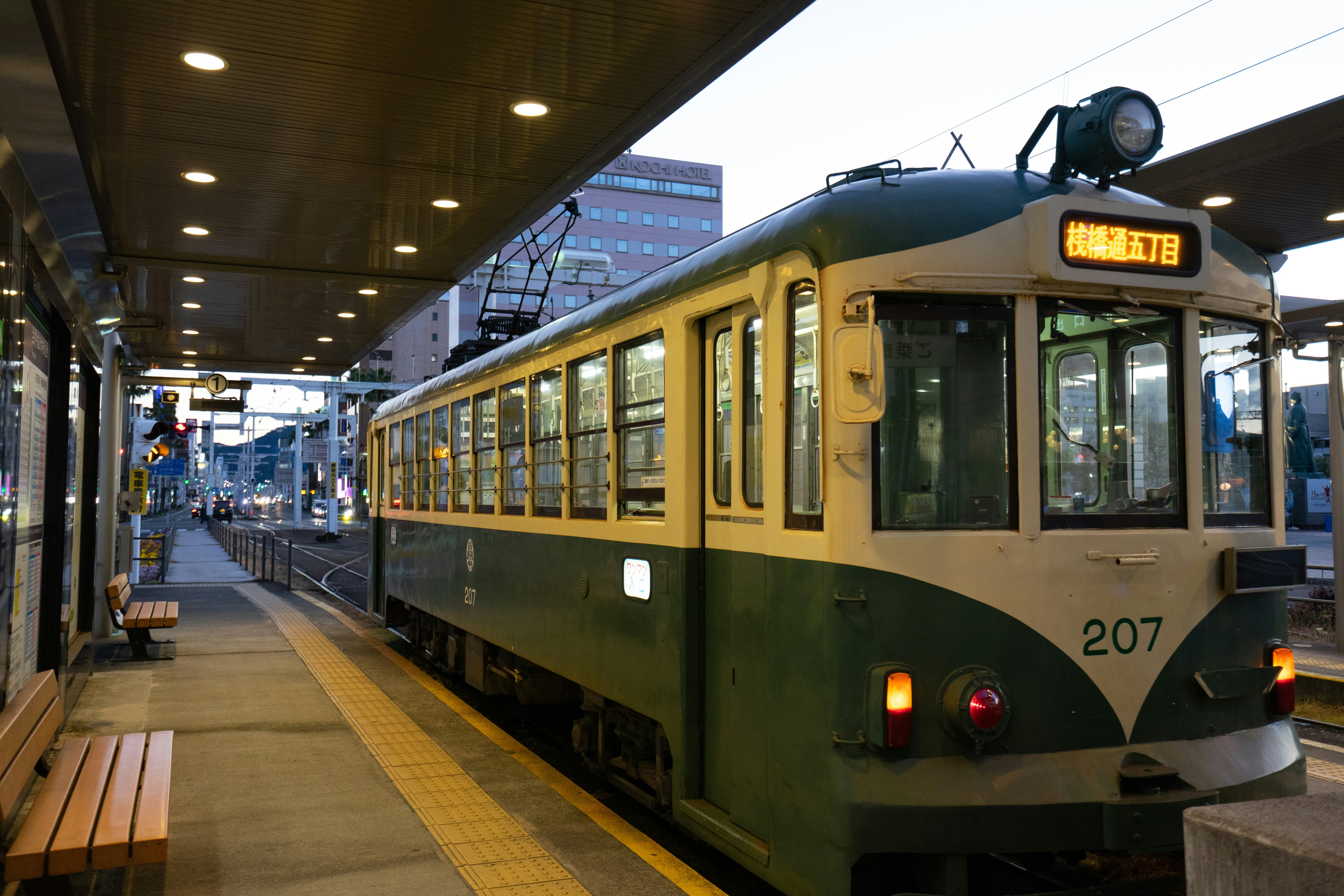 Old Green Streetcar at Quiet Urban Platform