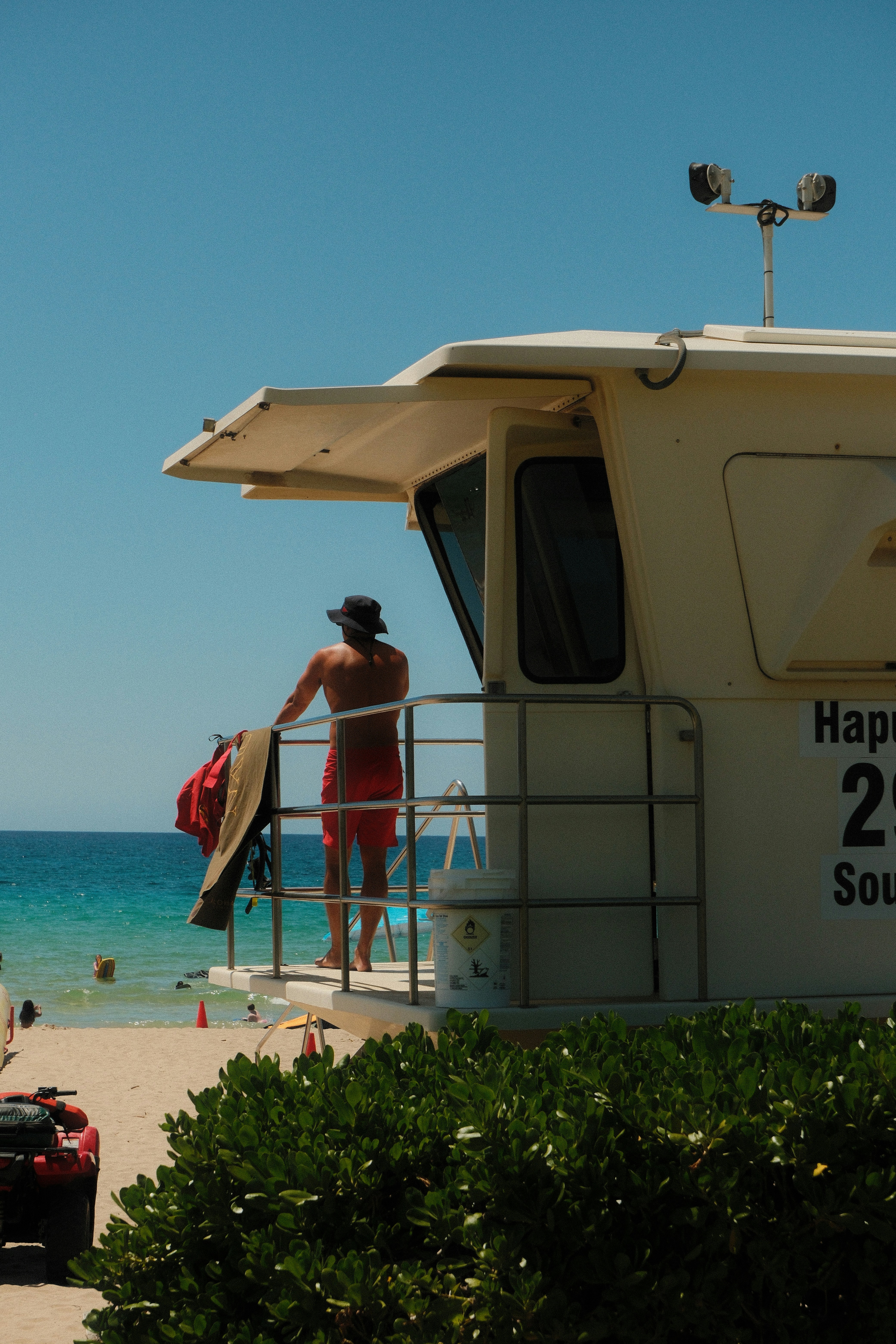  lifeguard on duty at sunlit beach lifeguard tower