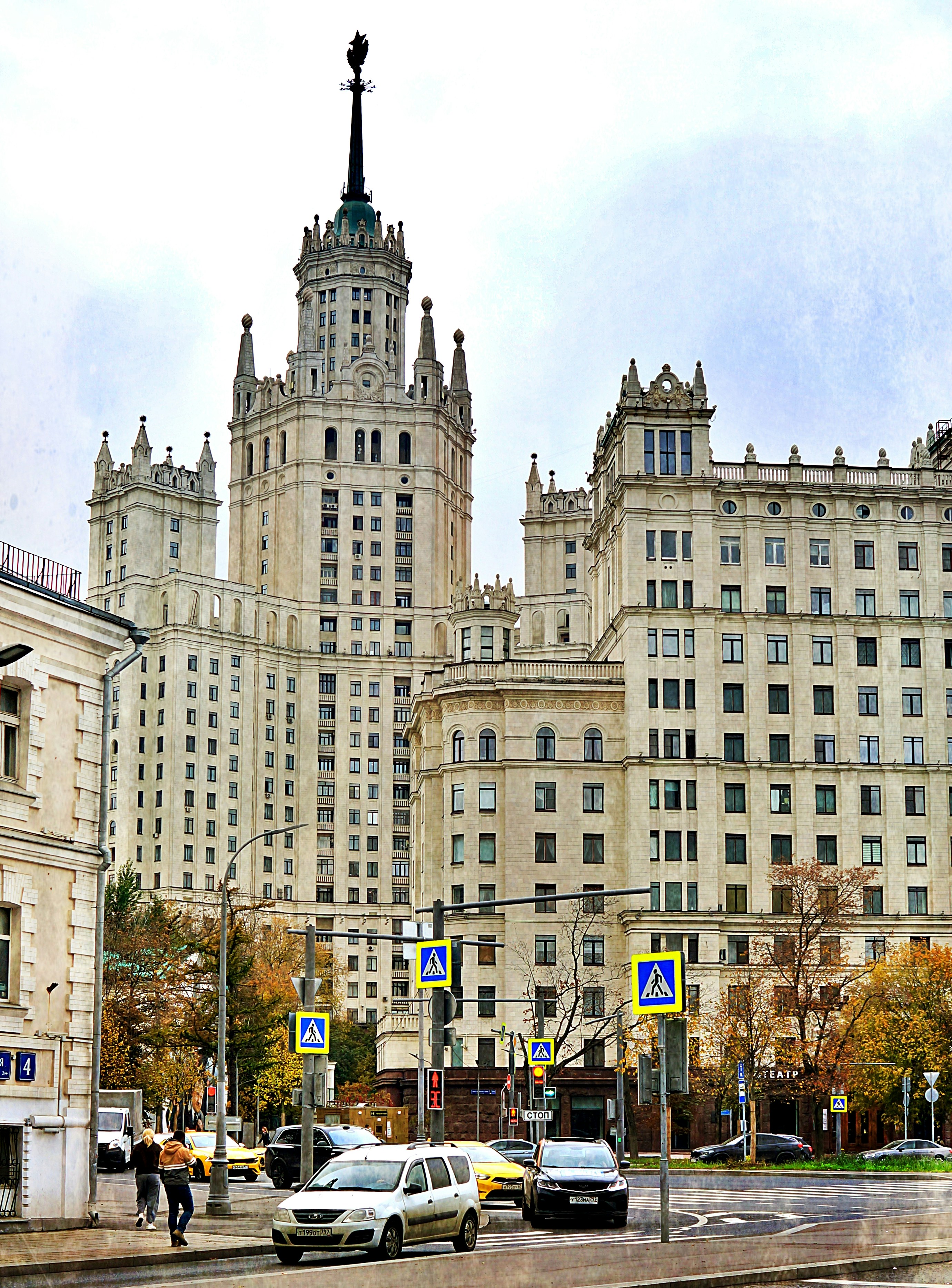 Gothic towers rise above a bustling city street