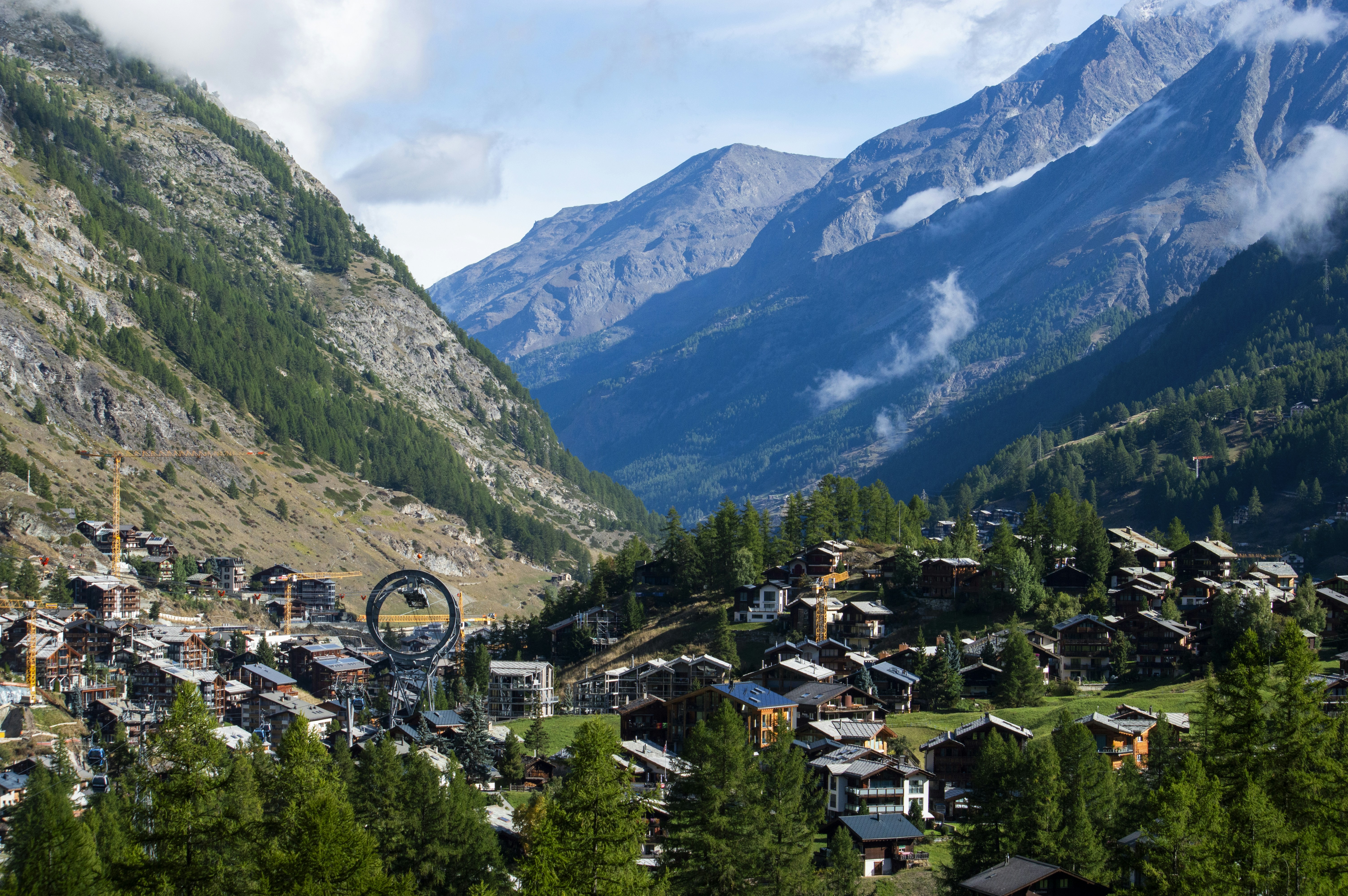 Alpine Village set beneath a cirrus-skied crest