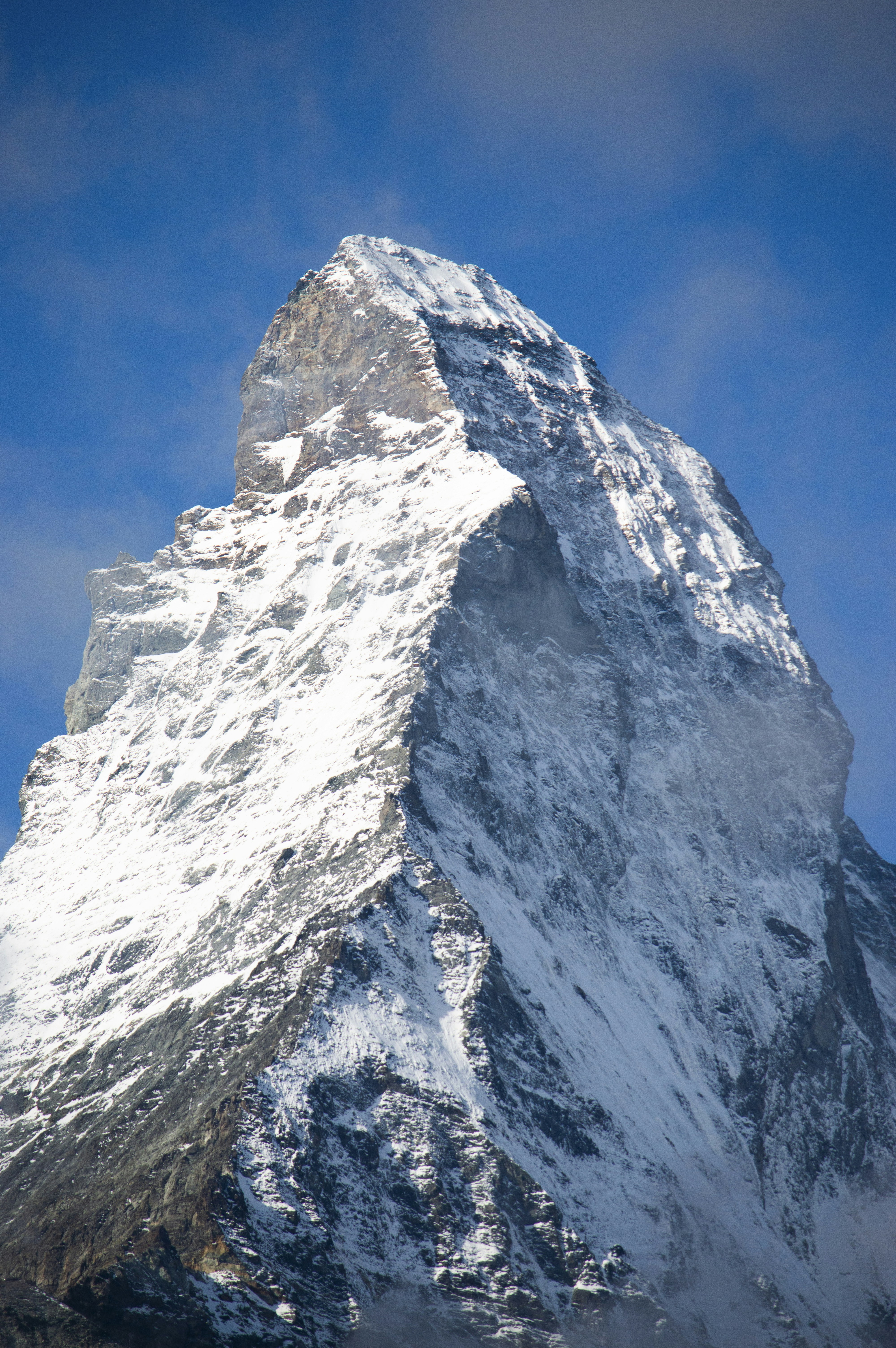 Peak Against the Blue: Snow-Capped Summit Reaching Toward Sky
