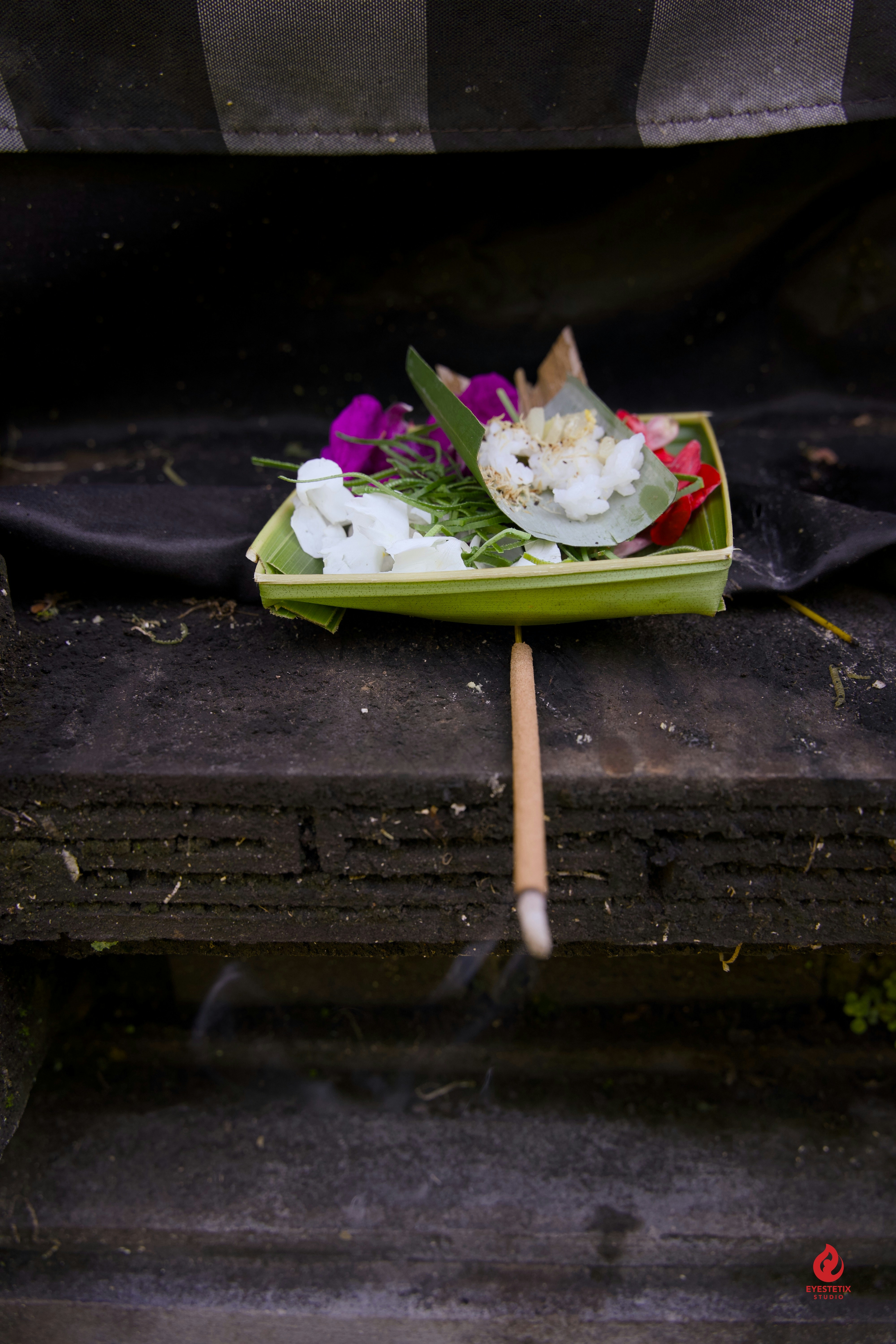 Ashes of Ceremony: A Single Incense Stick beside a Floating Offering