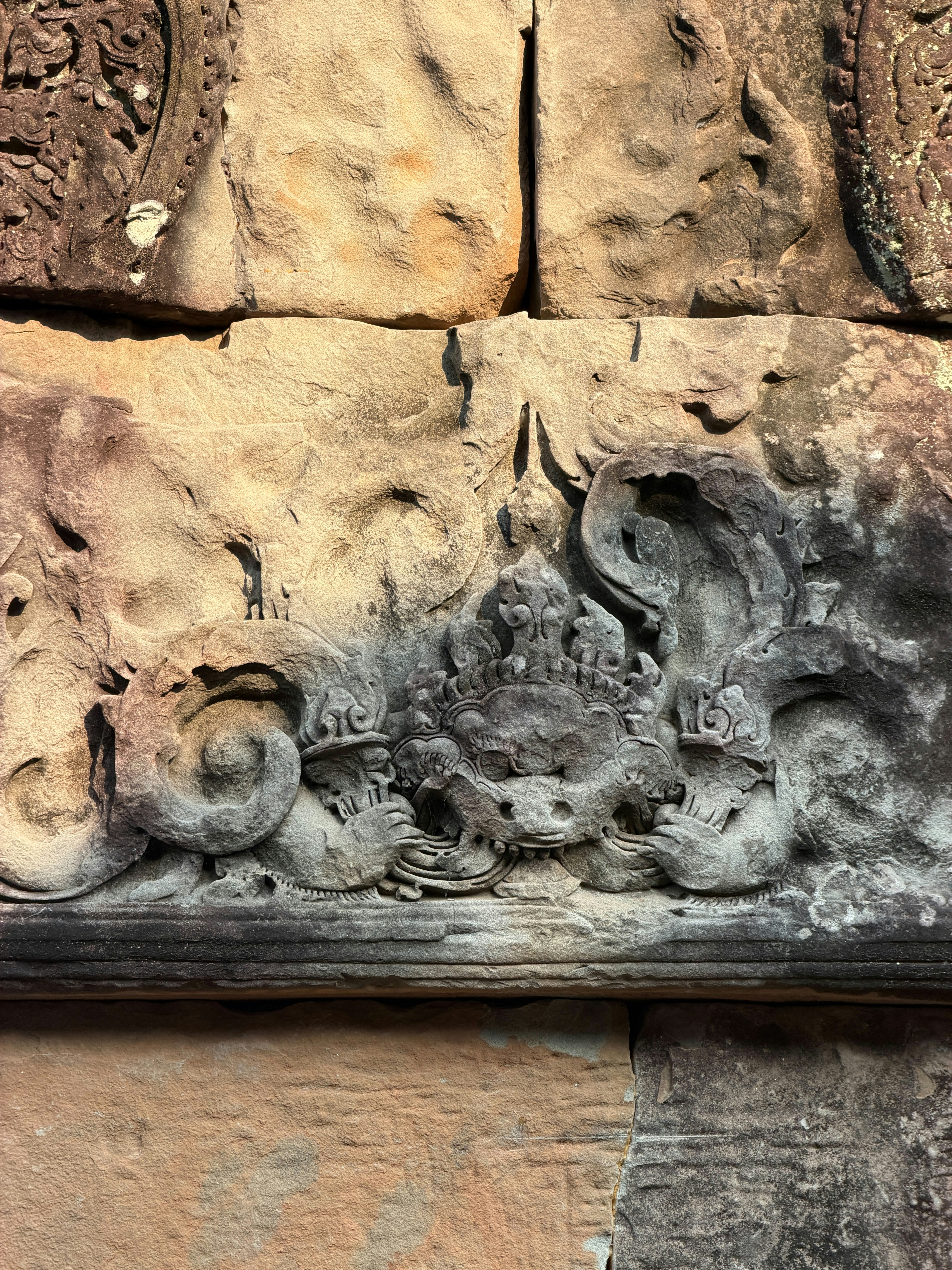 Carved stone relief in weathered temple wall