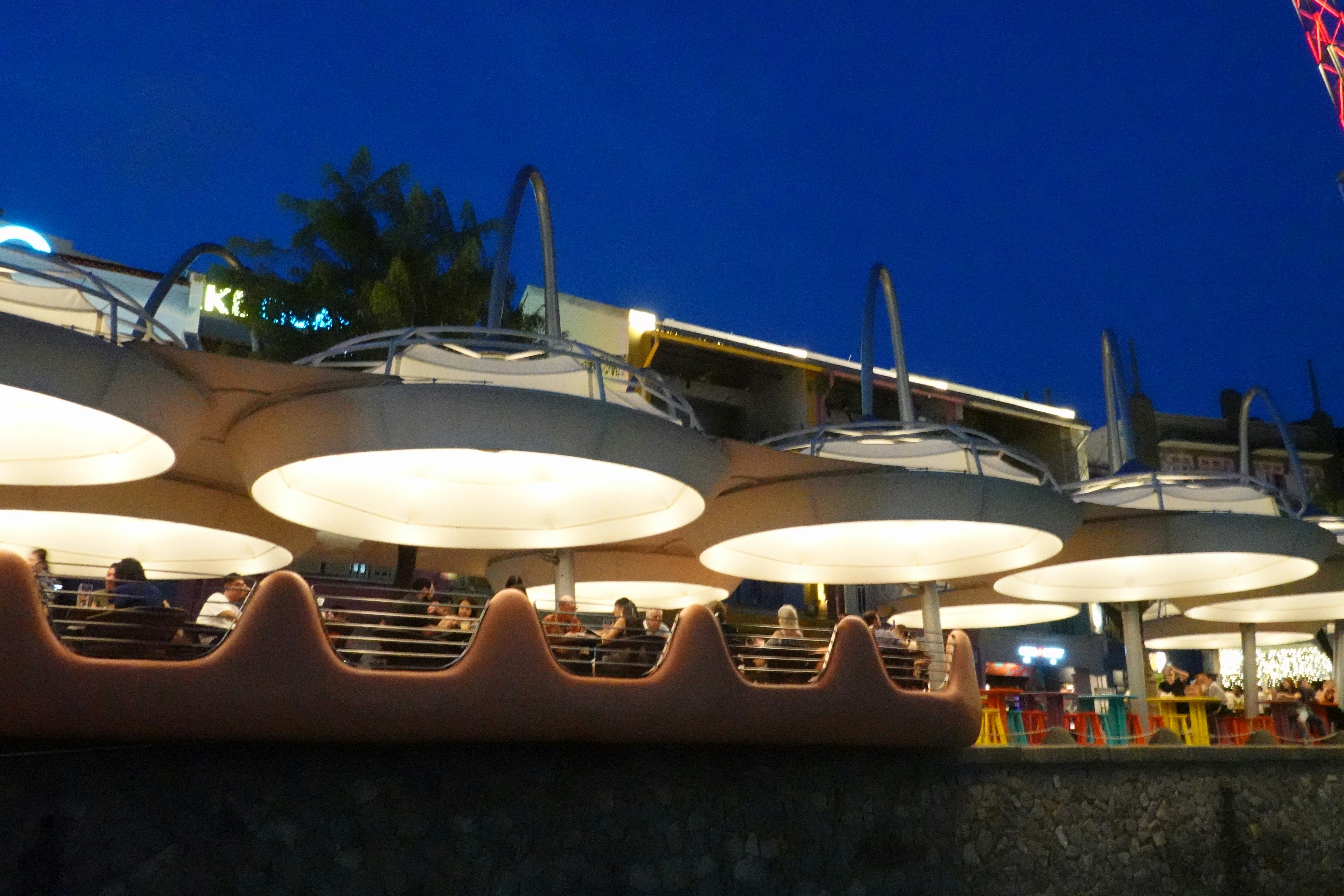 Circular Canopies and Evening Courtyard: A Night at the Waterfront