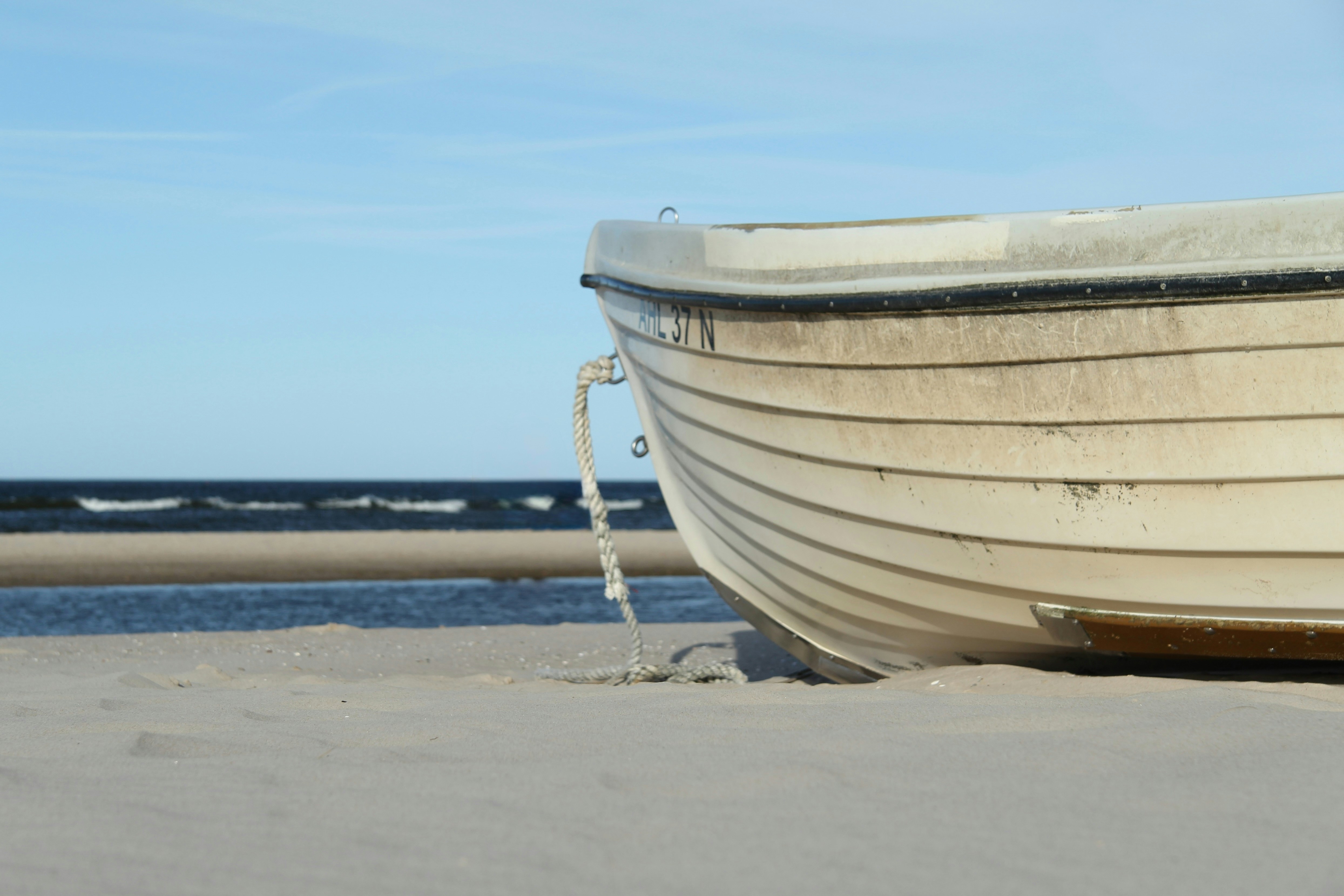 Beached Bow: A Weathered Boat Half Submerged in Sand