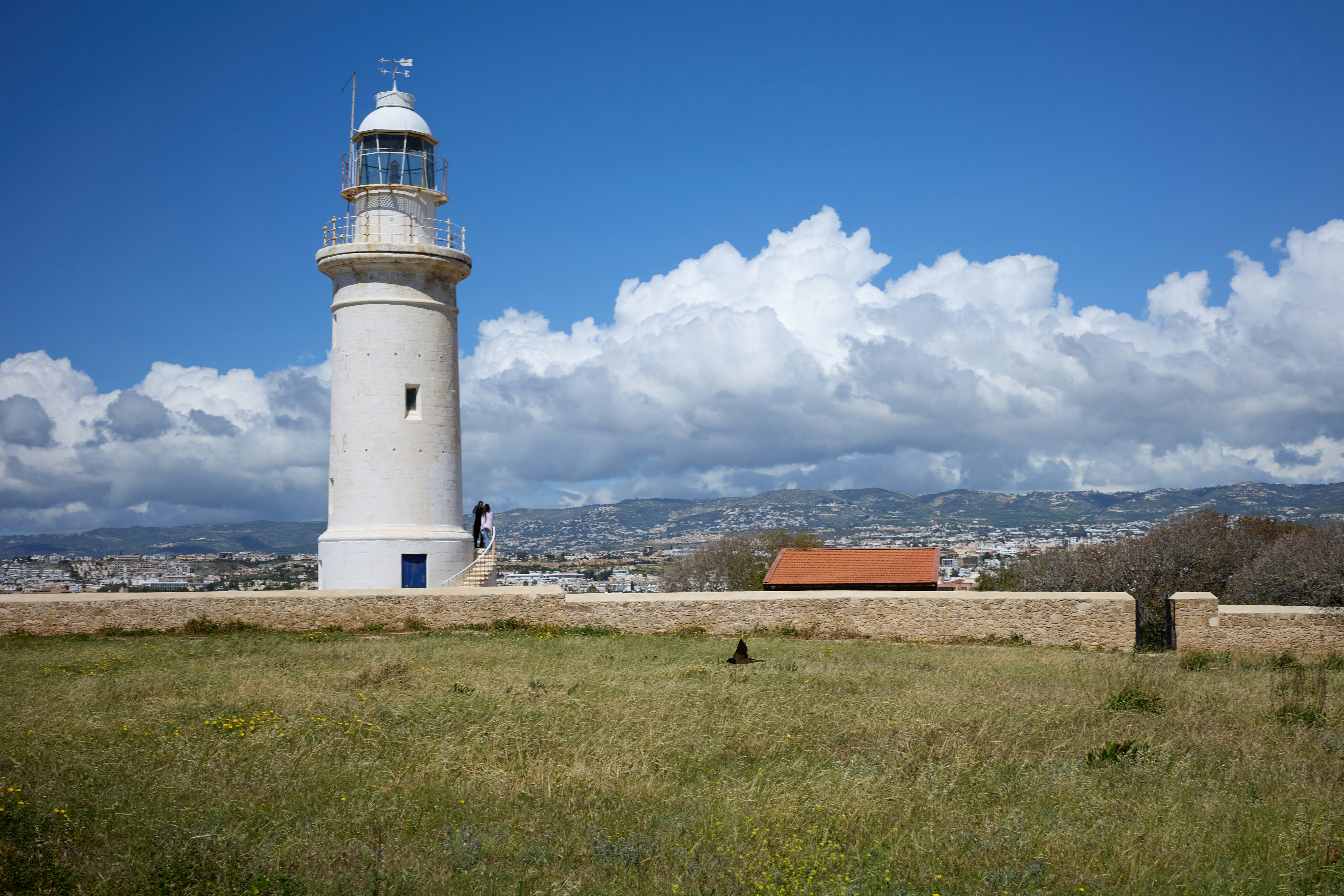 Coastal Sentinel: A White Lighthouse Standing Against a Wide Atlantic Sky