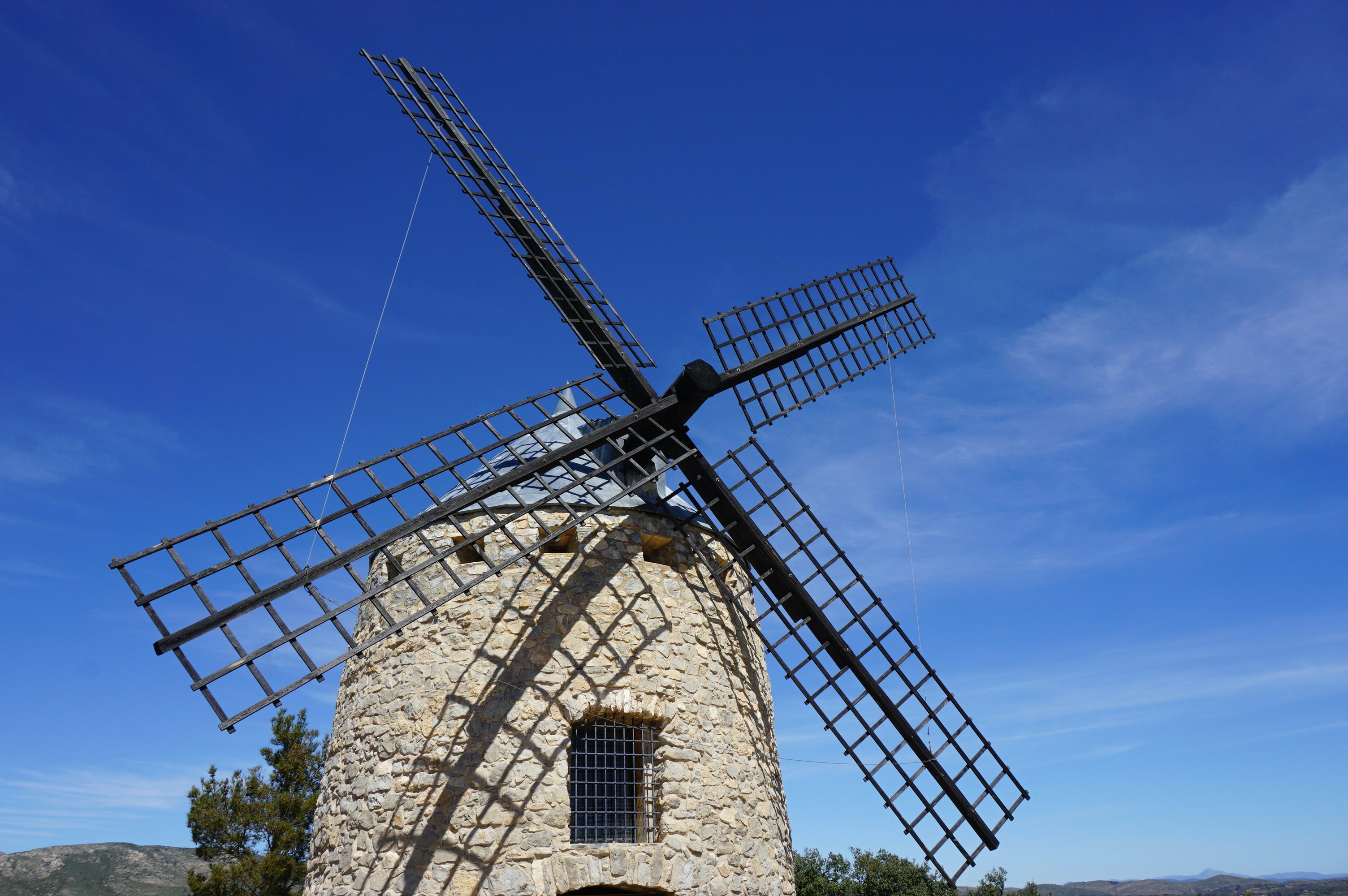 Stone Windmill Under a Wide Blue Sky