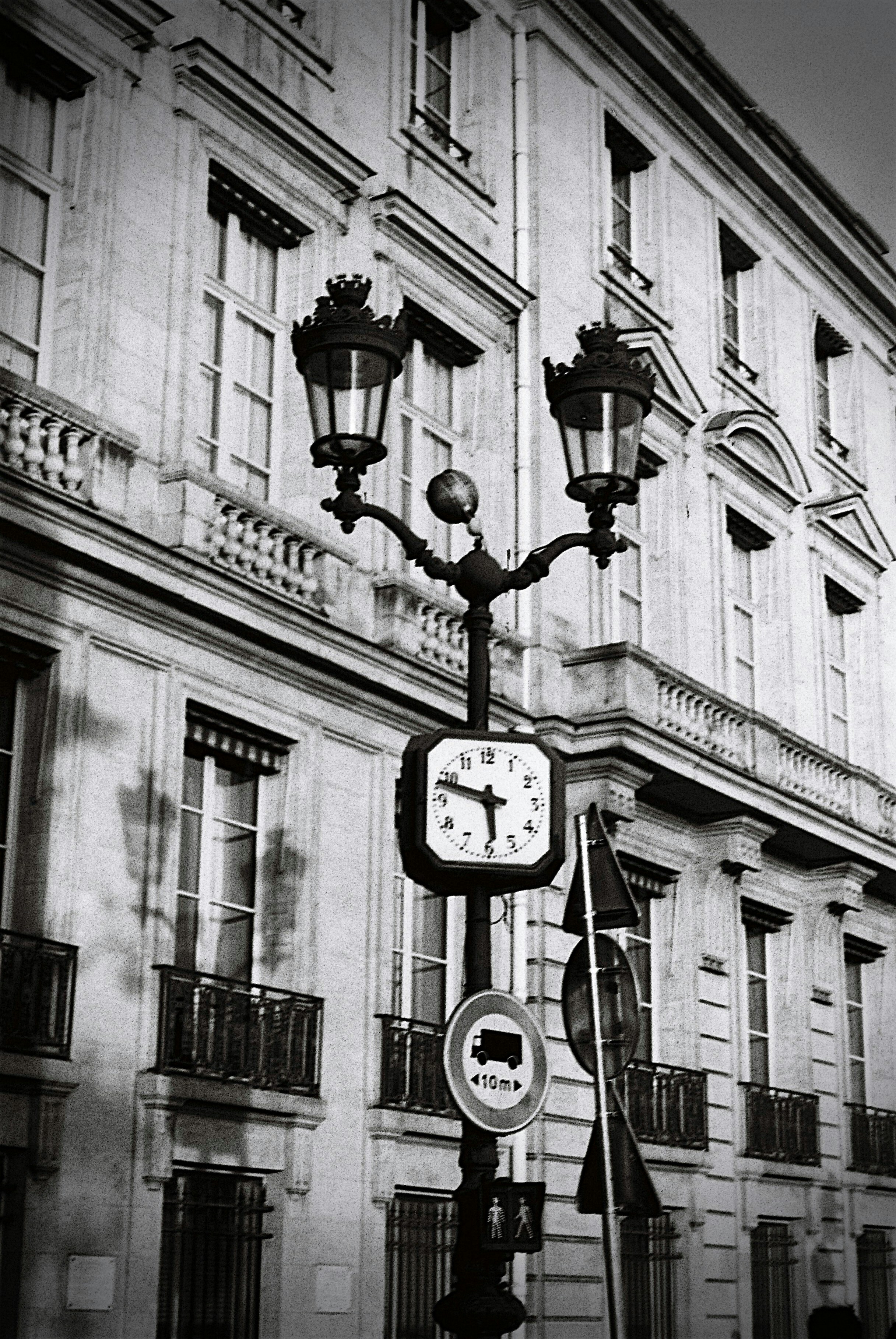 Clock and Lanterns: A Timeless Street Corner in Monochrome