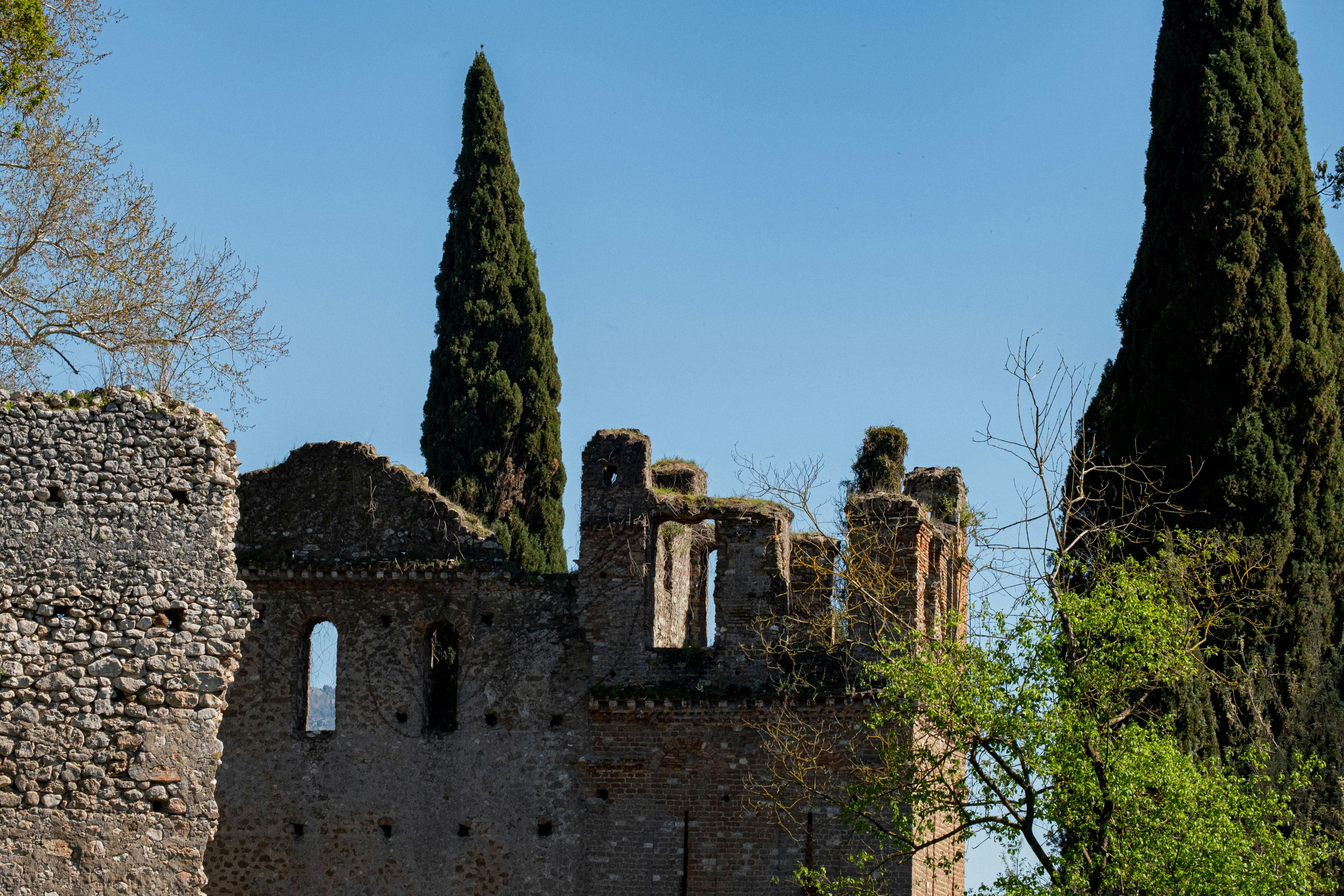 Ruins Under a Clear Sky: A Slice of Time Among Cypresses