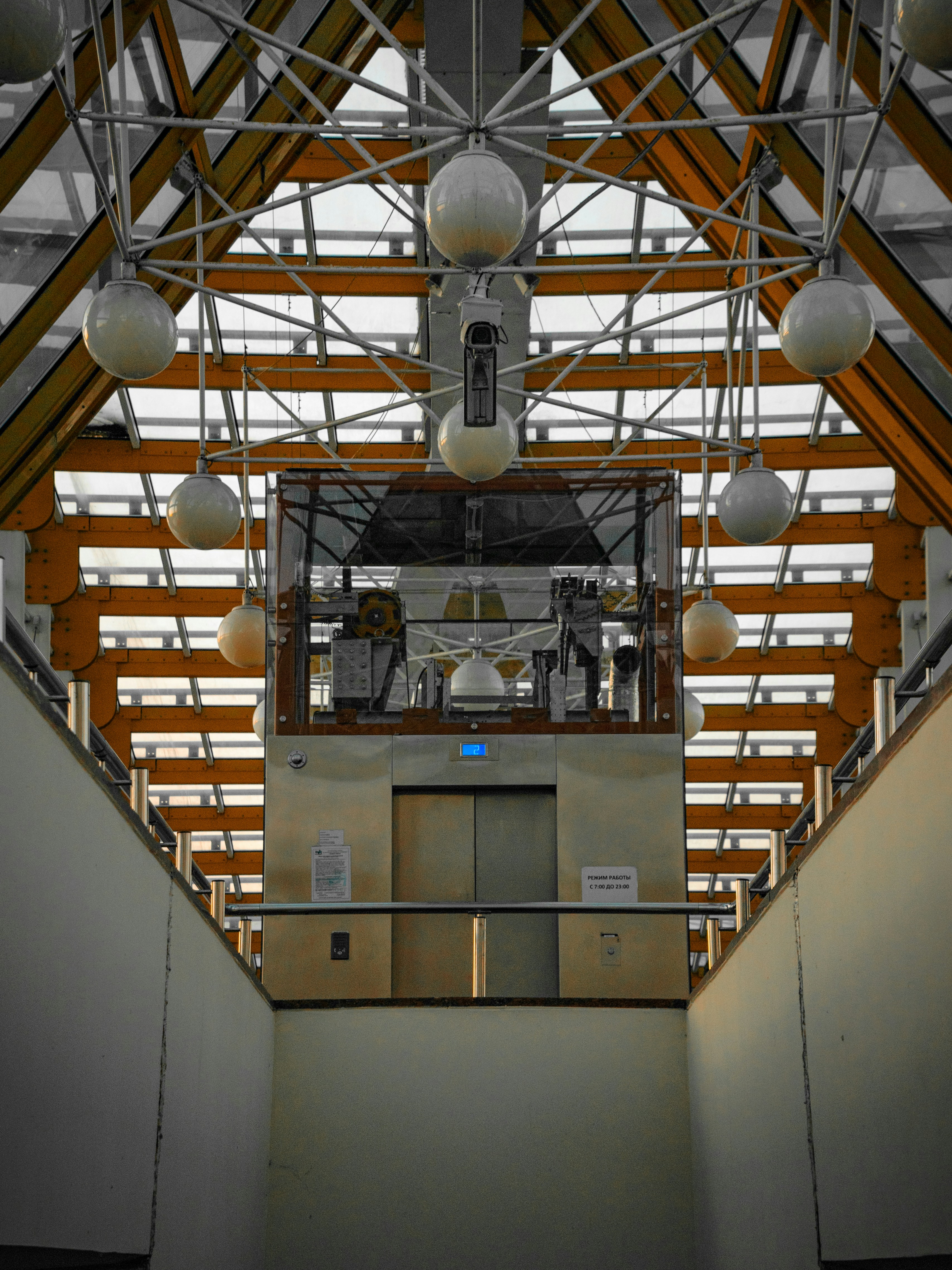Symmetrical Elevator Atrium: A Geometric Cage of Light and Steel