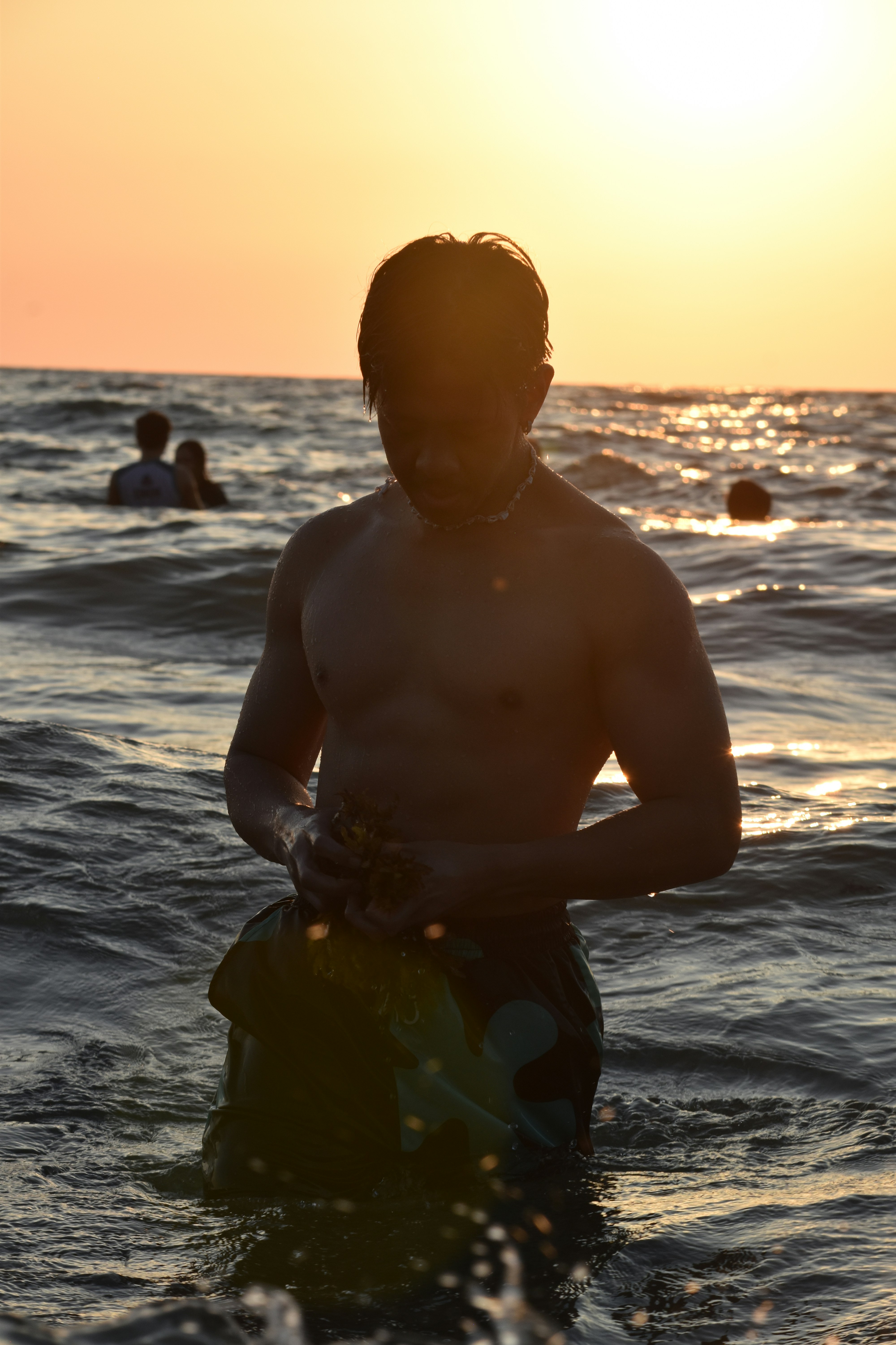 Sunlit Silhouette: a swimmer at the edge of day