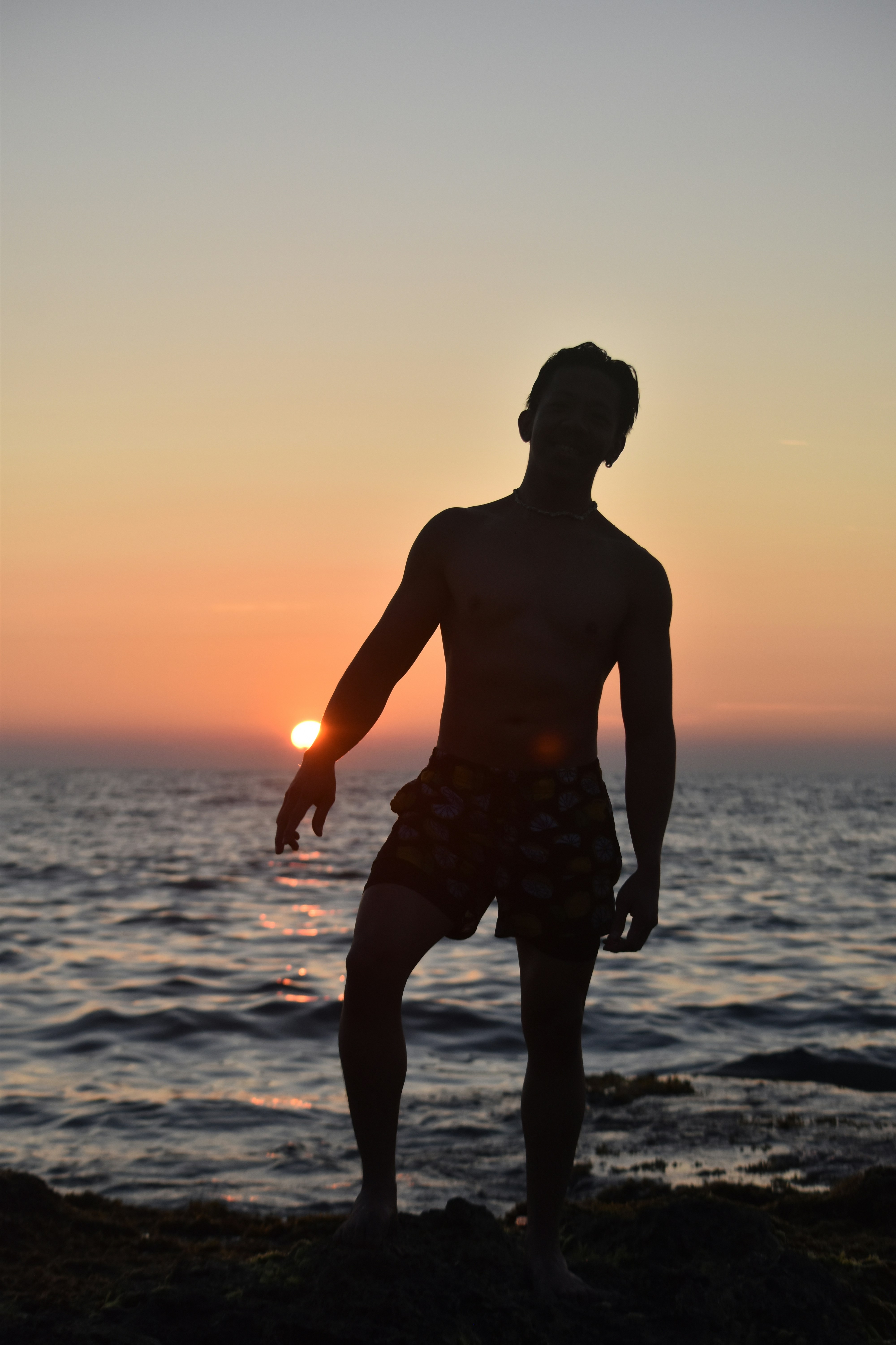 Silhouette at Sunset: A Lone Figure on the Shore