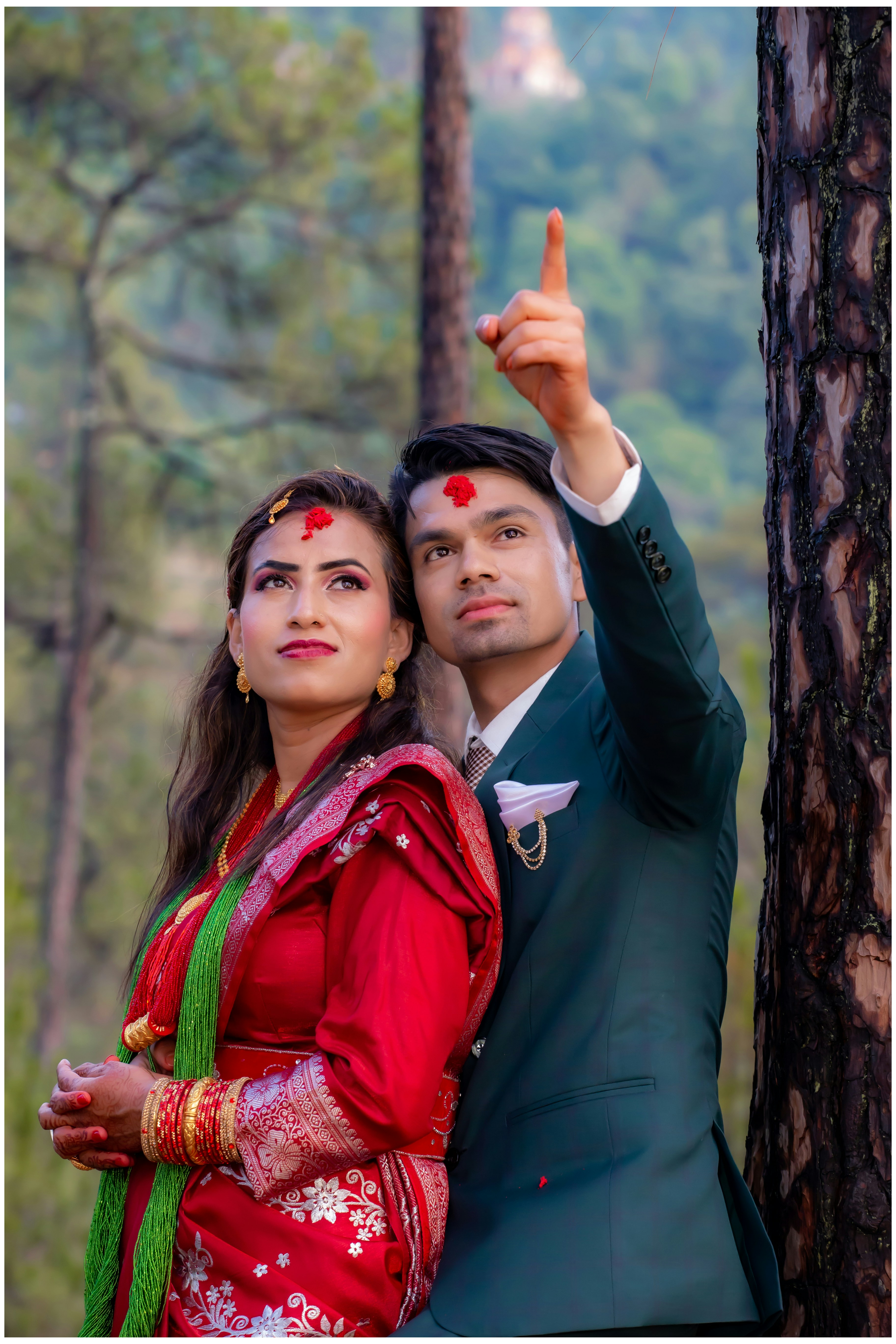 Together Under the Tall Pines: A Bride and Groom Point to the Sky