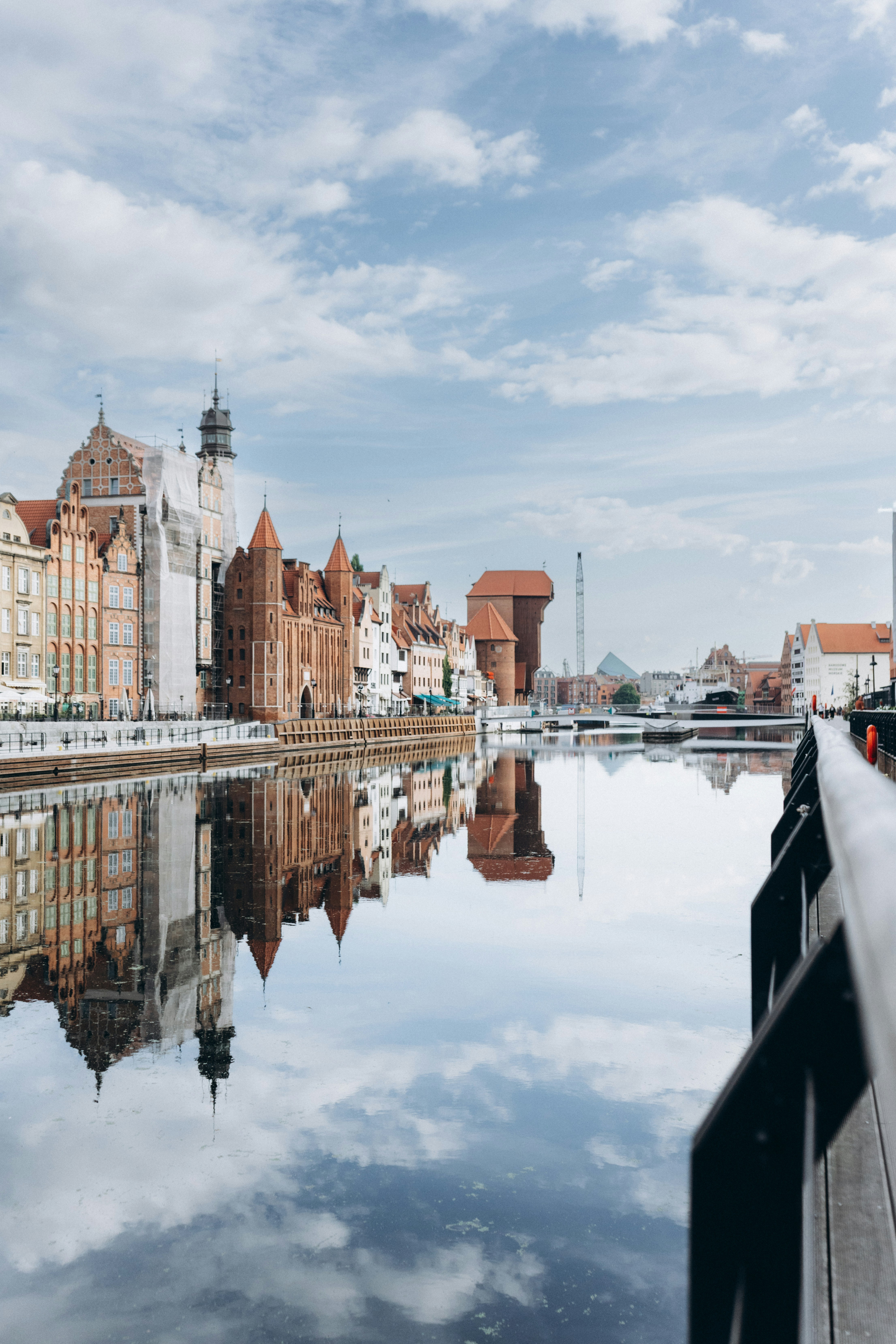 A Serene Canalfront: Historic Gabled Facades and Sky Reflections