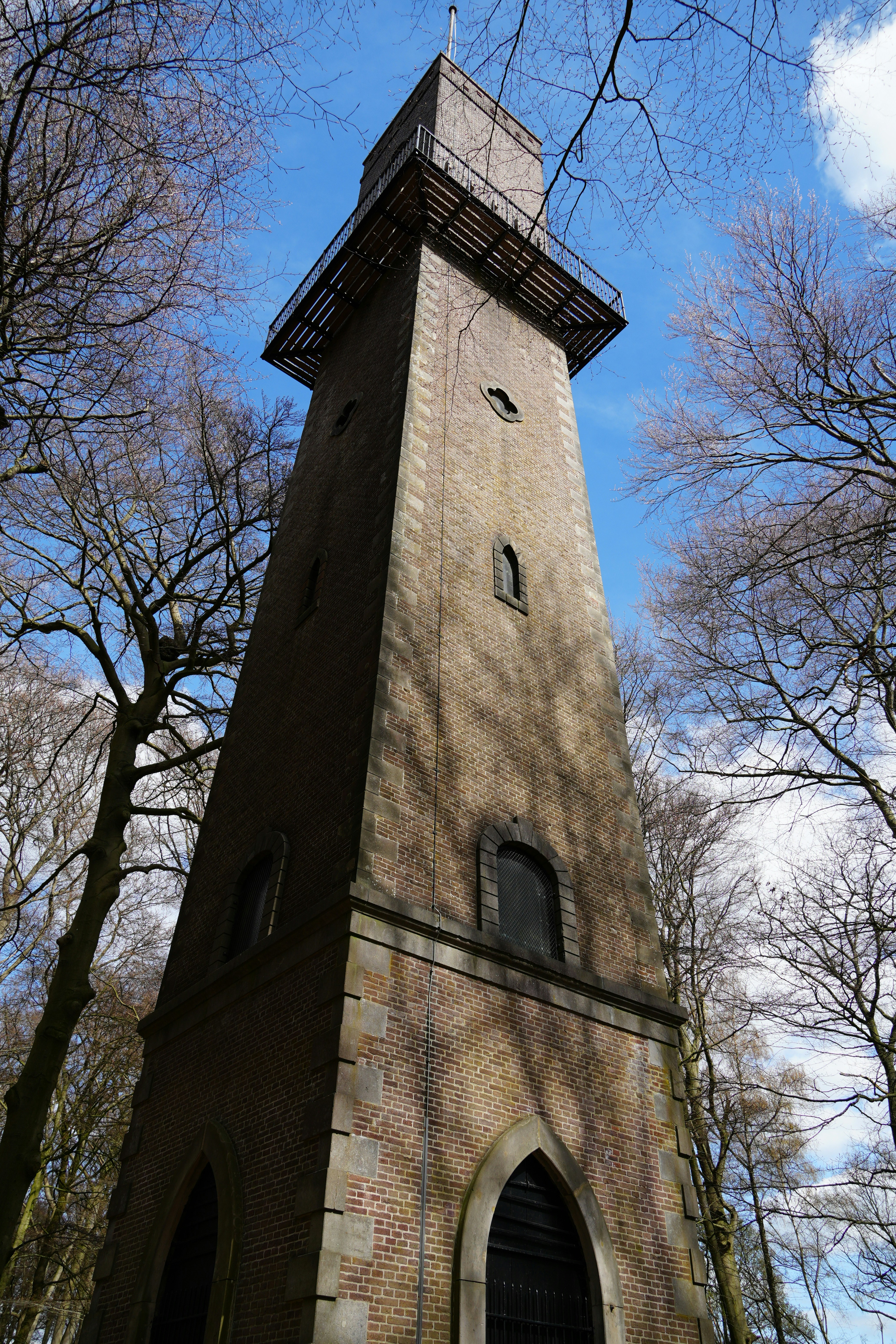 A Brick Tower Reaching Toward a Blue Sky