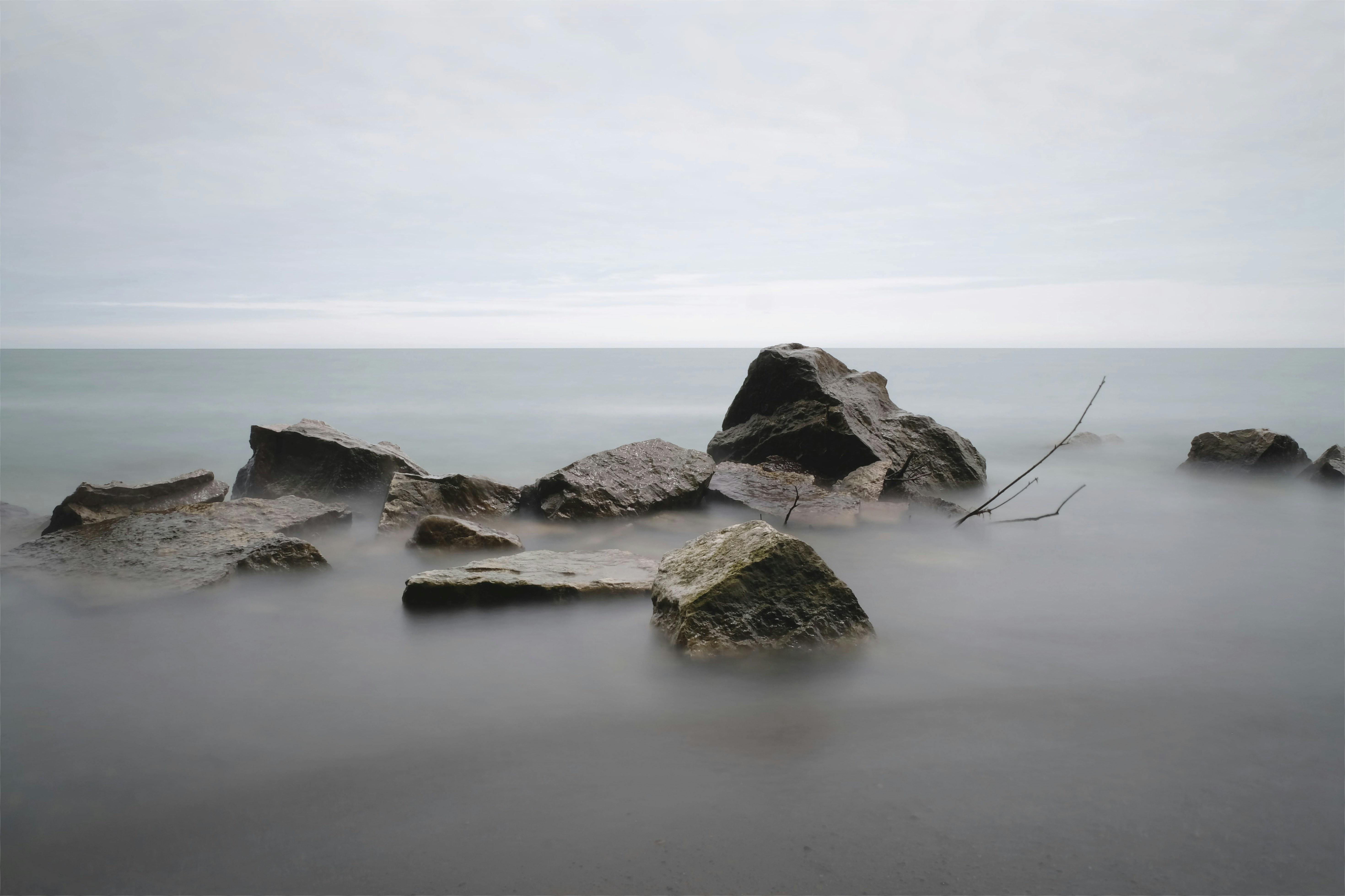 Stone choir at sea: a calm balance of rock and tide