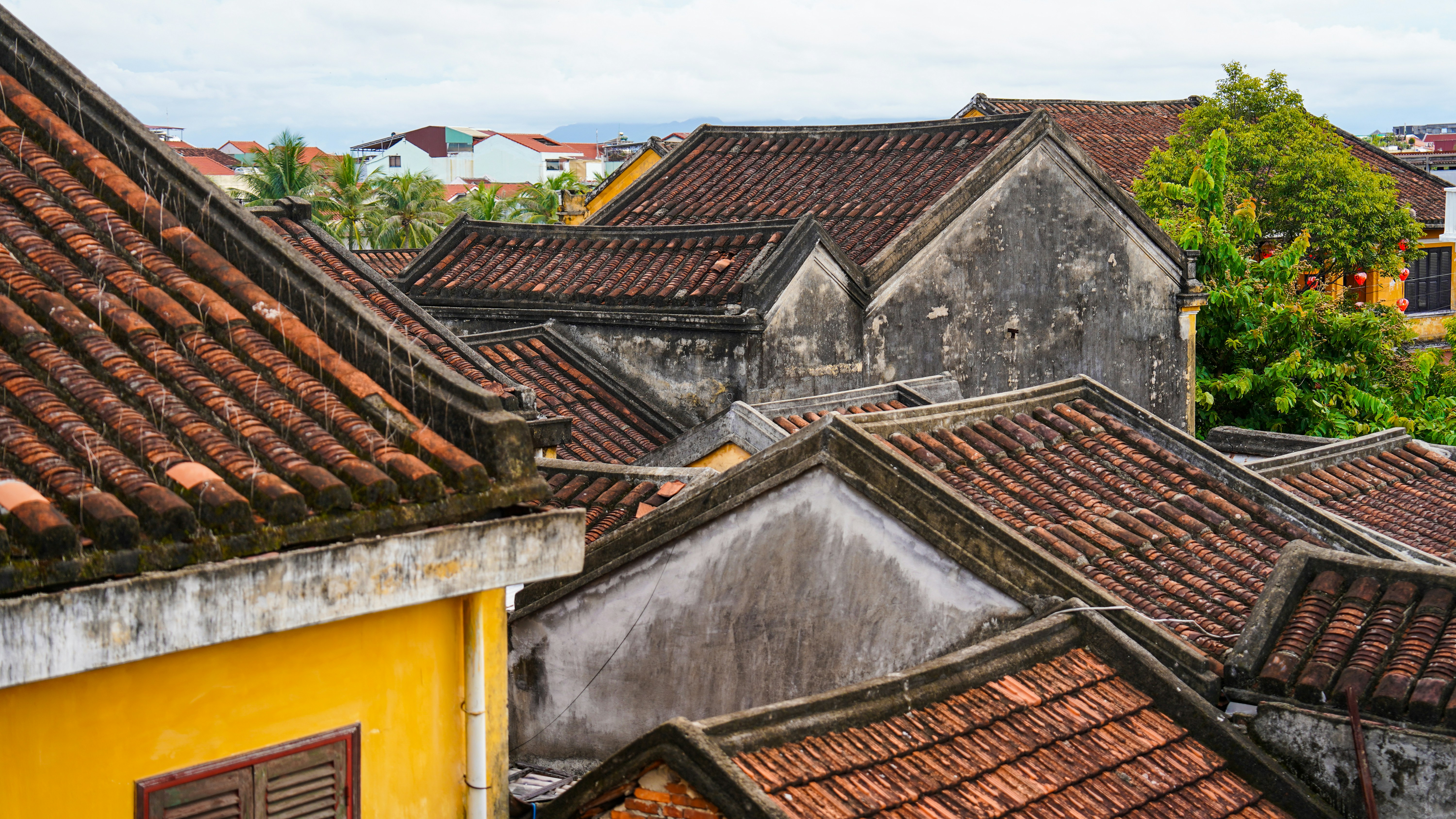 Yellow Cornerstone Among Weathered Tiles