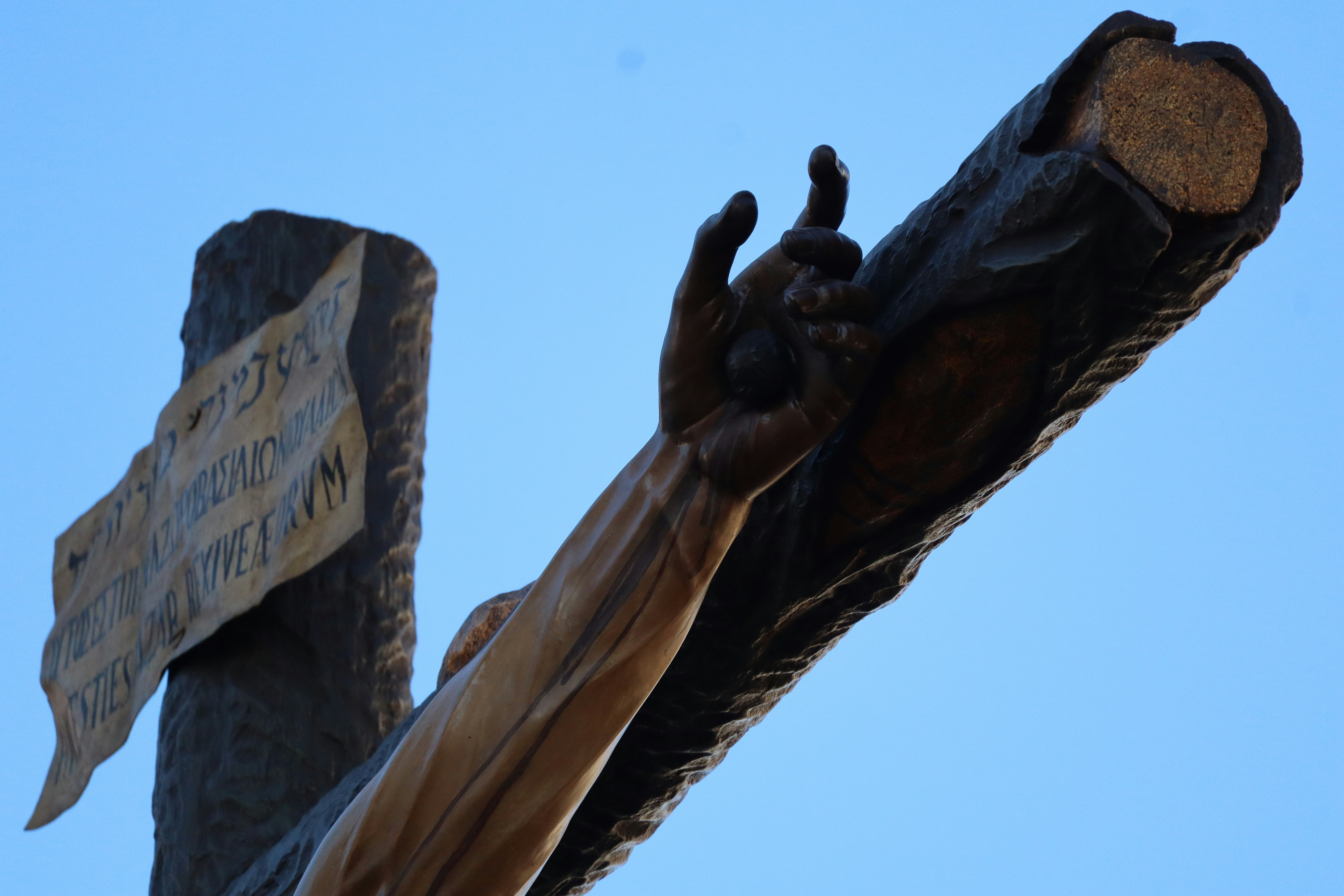Carved Hands and Fragmented Cross: A Quiet Monument in the Sky