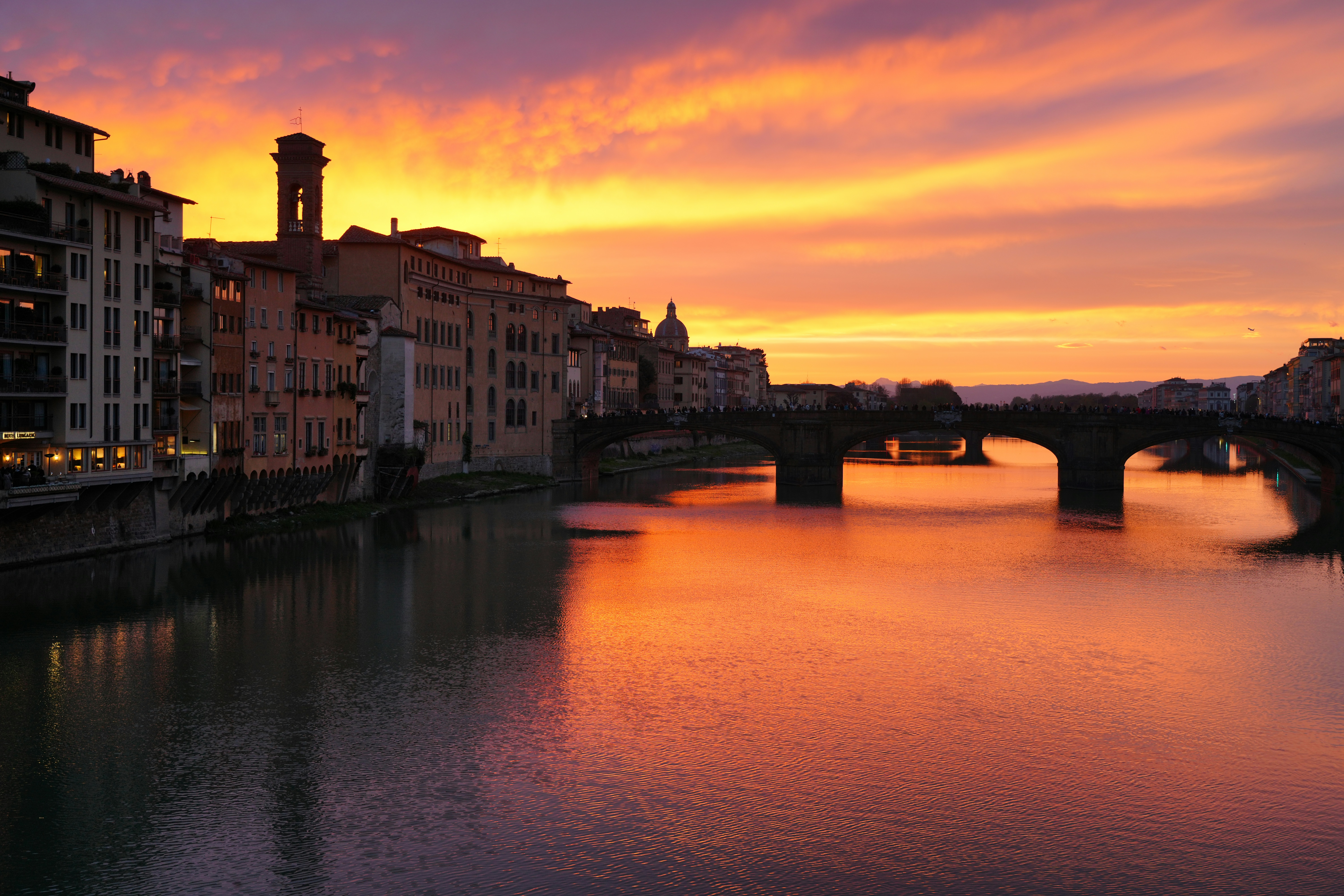 Golden Hour Over the Arno: Sunset Silhouette by the Ponte Vecchio