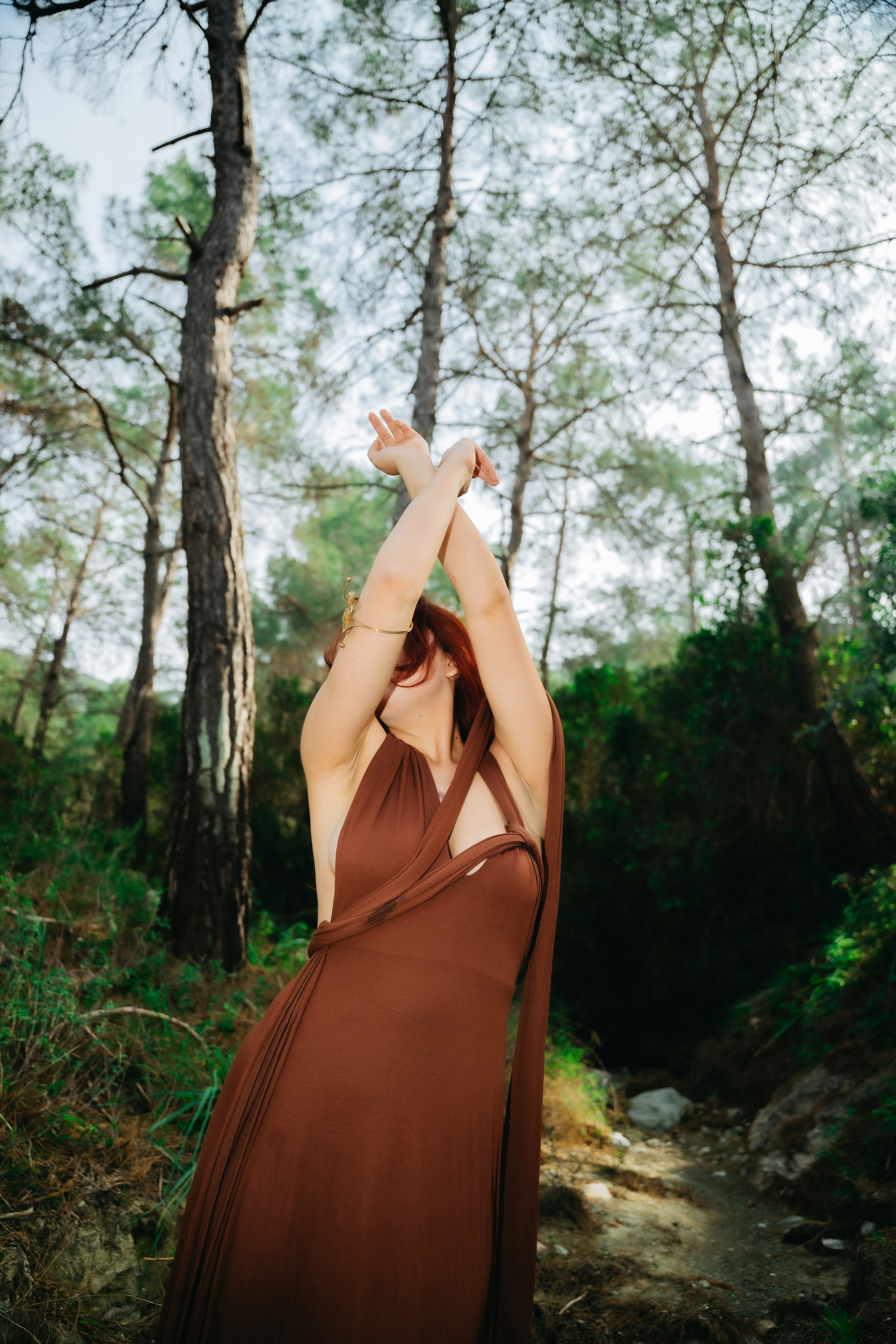 Earth-toned dress, forest light: a dancer in the pines