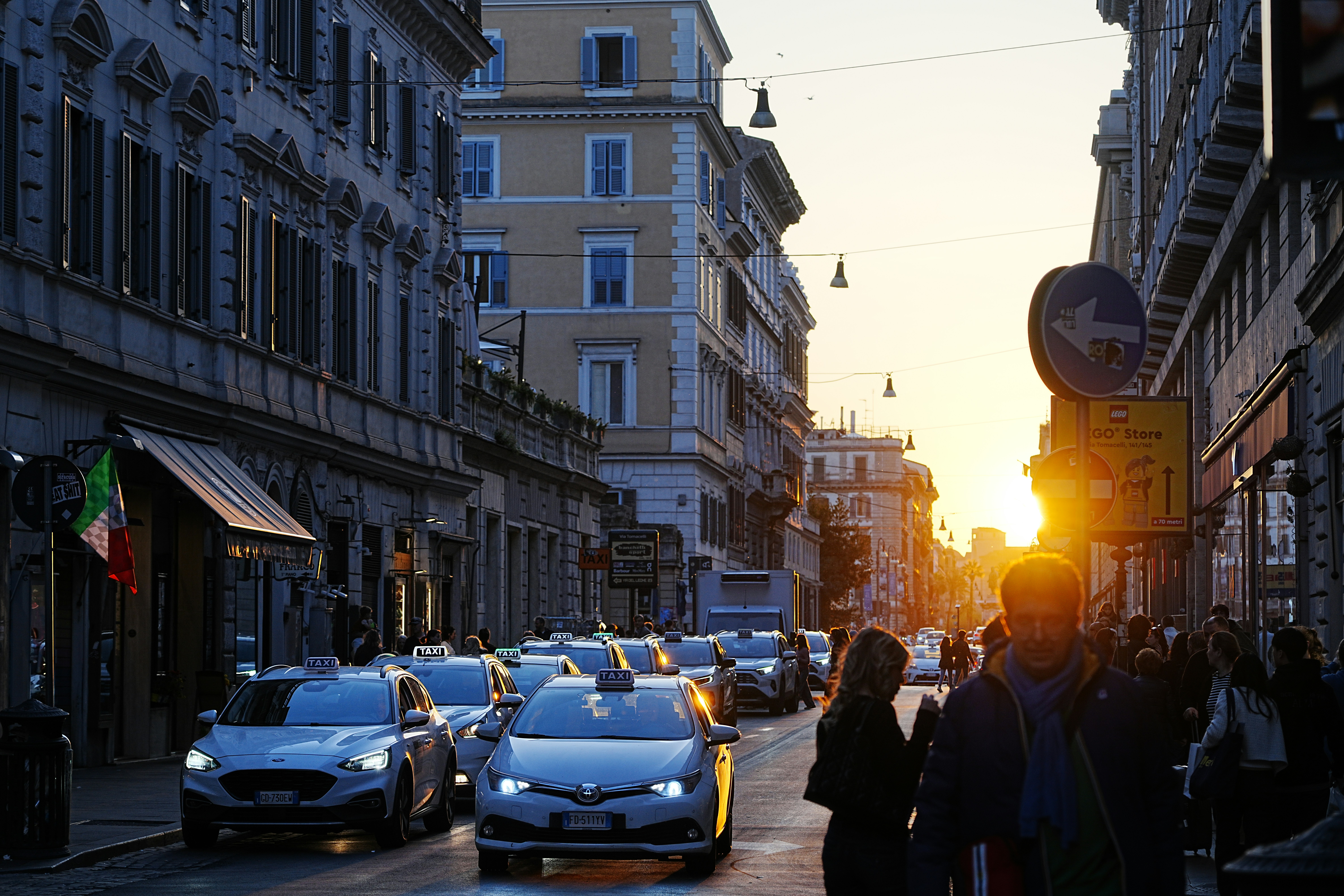 Golden Hour Rush: Traffic, Pedestrians, and City Lighting