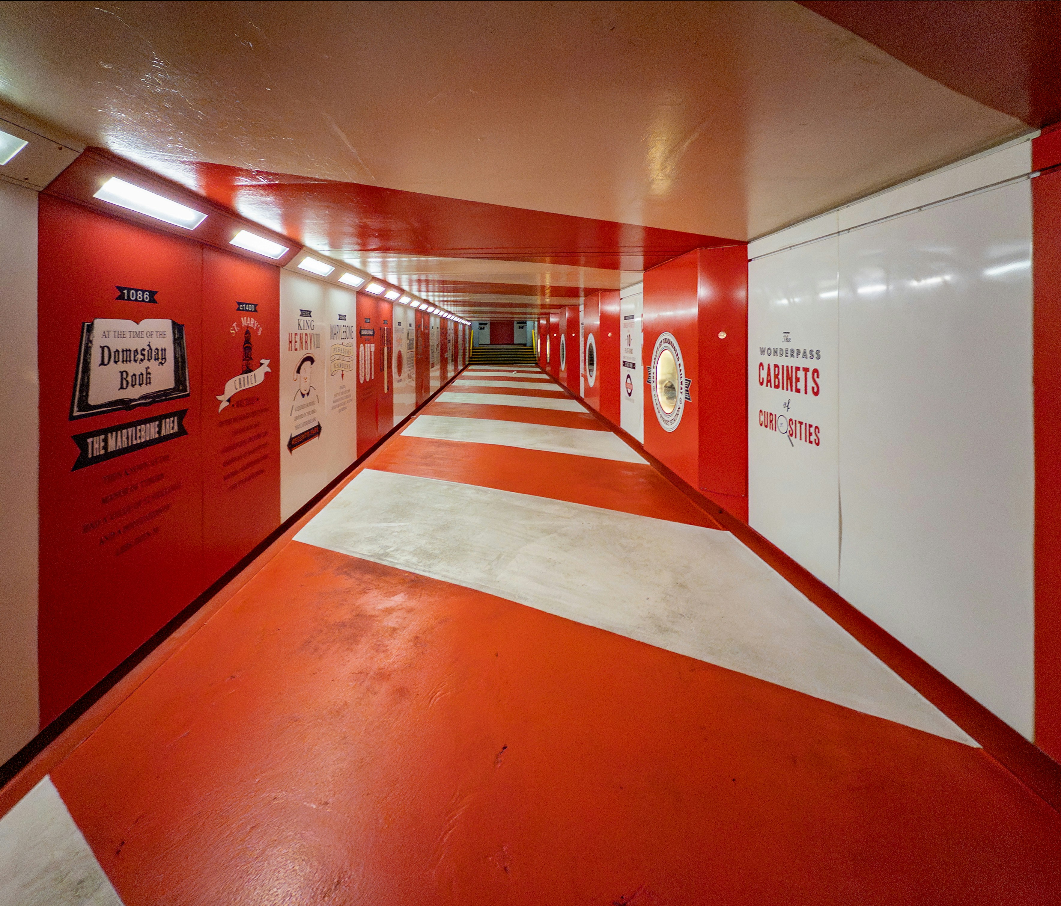 Red Corridor Through a Museum-Like Passage with White Stripes