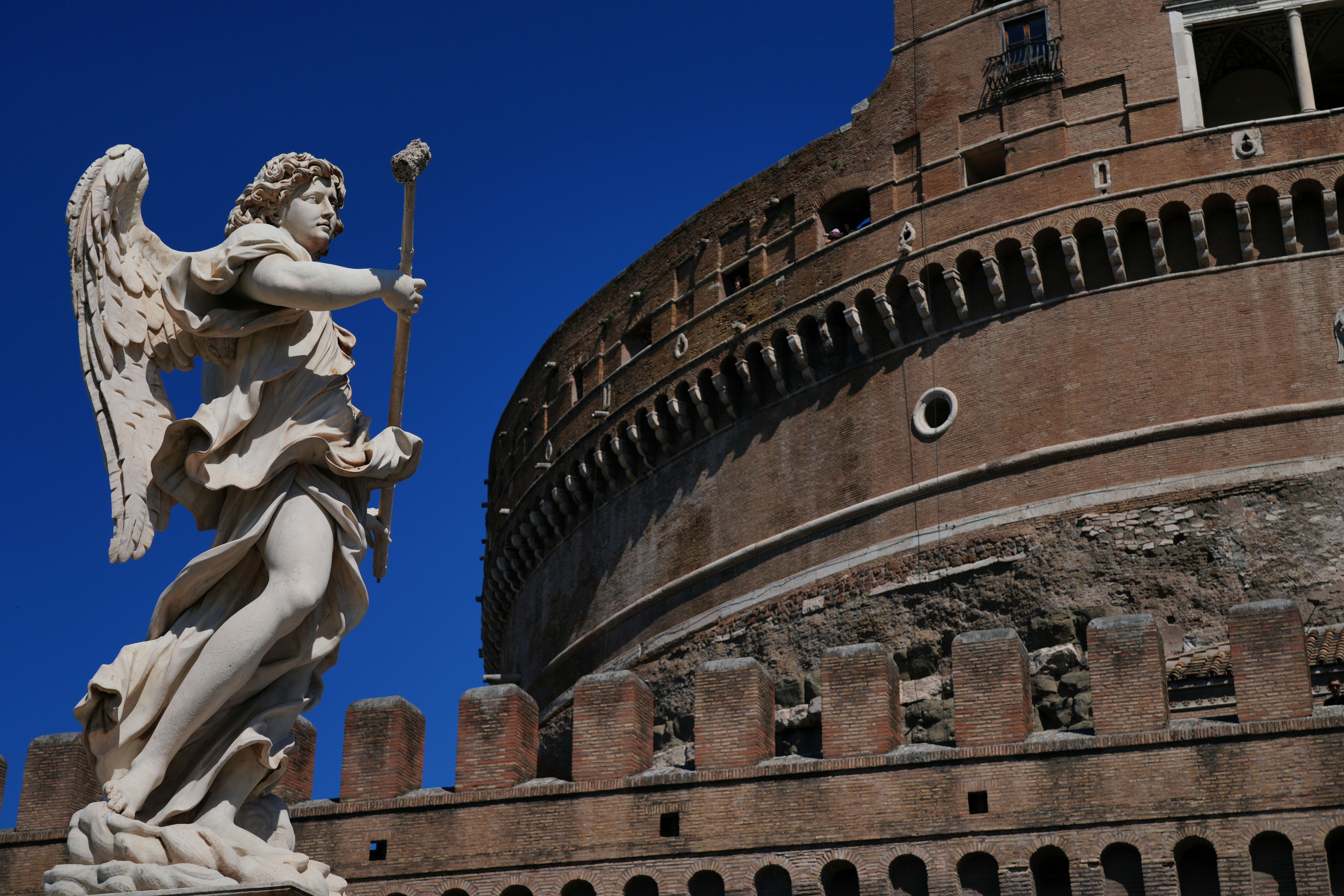 Stone Guardian and Towered Silence: A Statue’s Contrast Against Bricked Fortitude