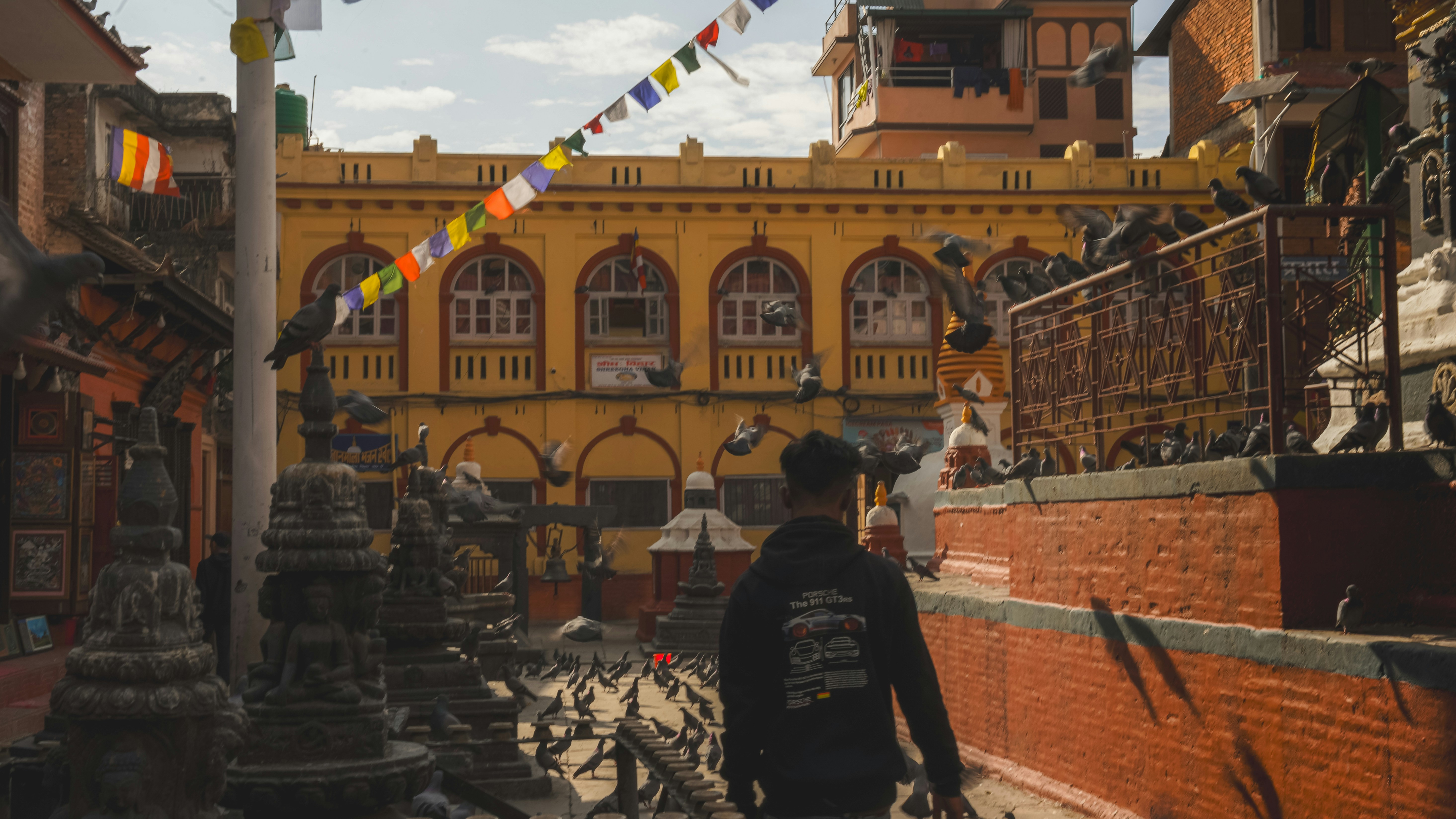 Urban Staircase Parade: A Traveler Watches the Temple Courtyard