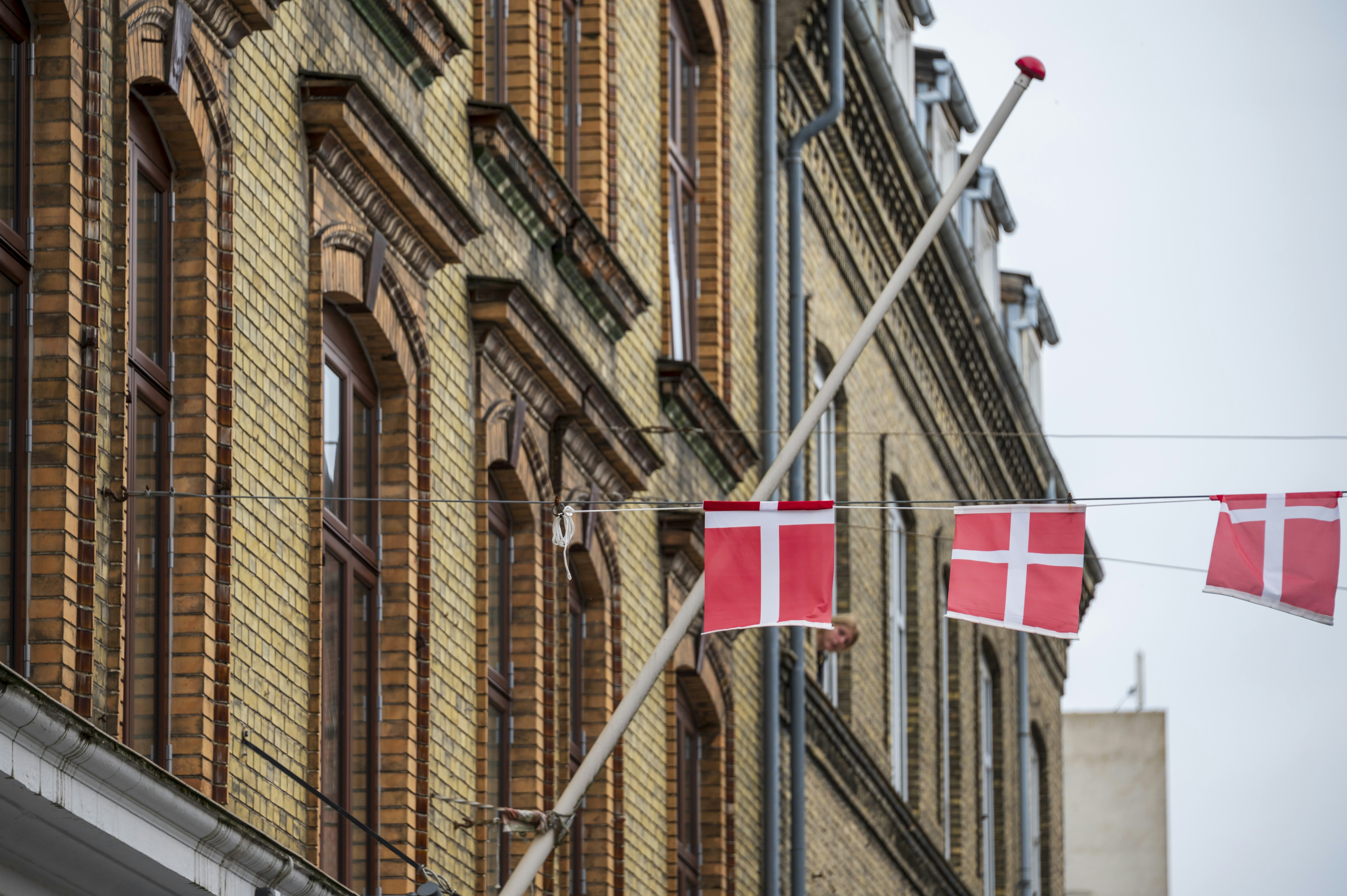Brick Facade and Flag Parade Along a Street