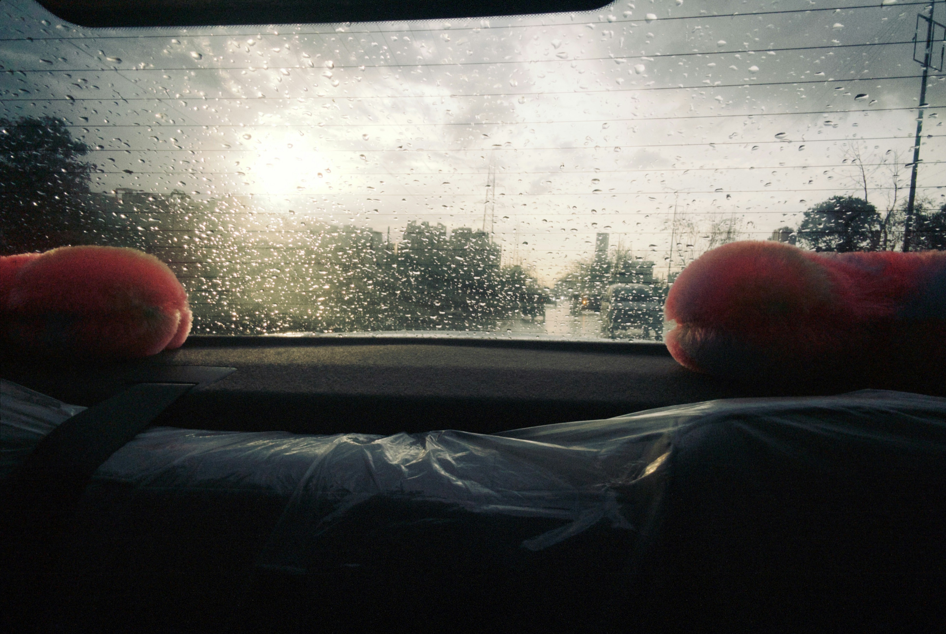 Rear Window Rain: Sunset Drive Through a Damp Night