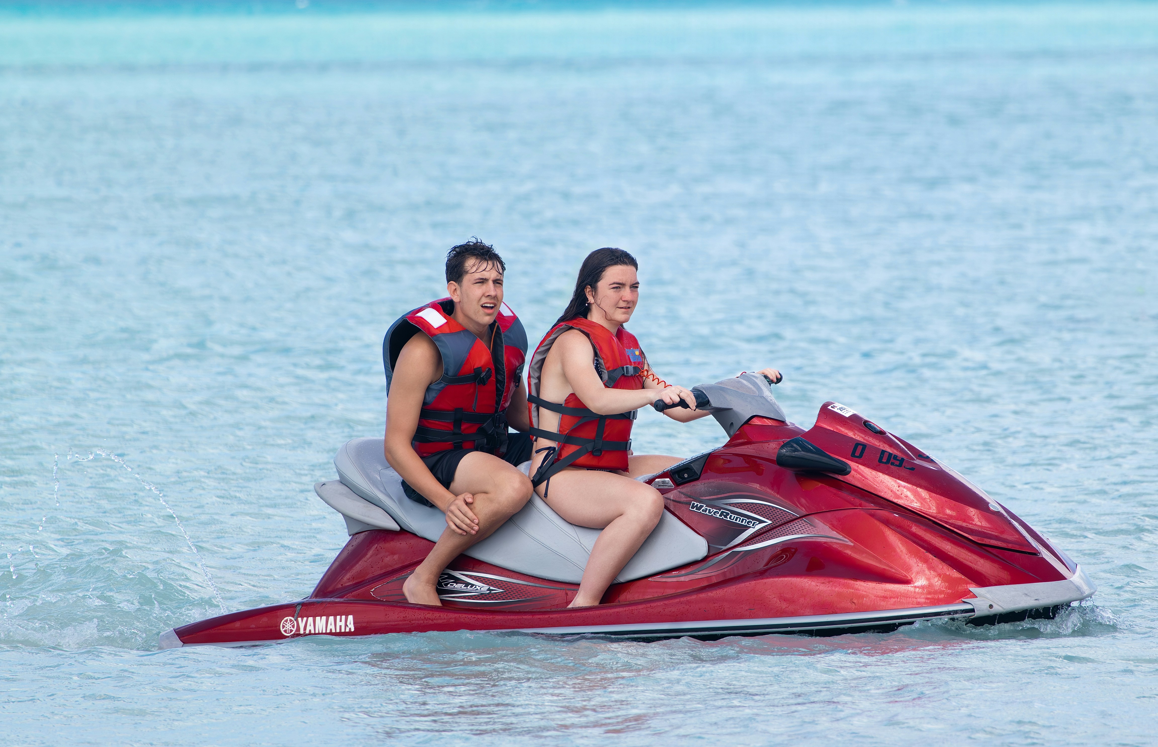 Two Riders on a Red Yamaha Jet Ski Cut Across Calm Aegean Blues